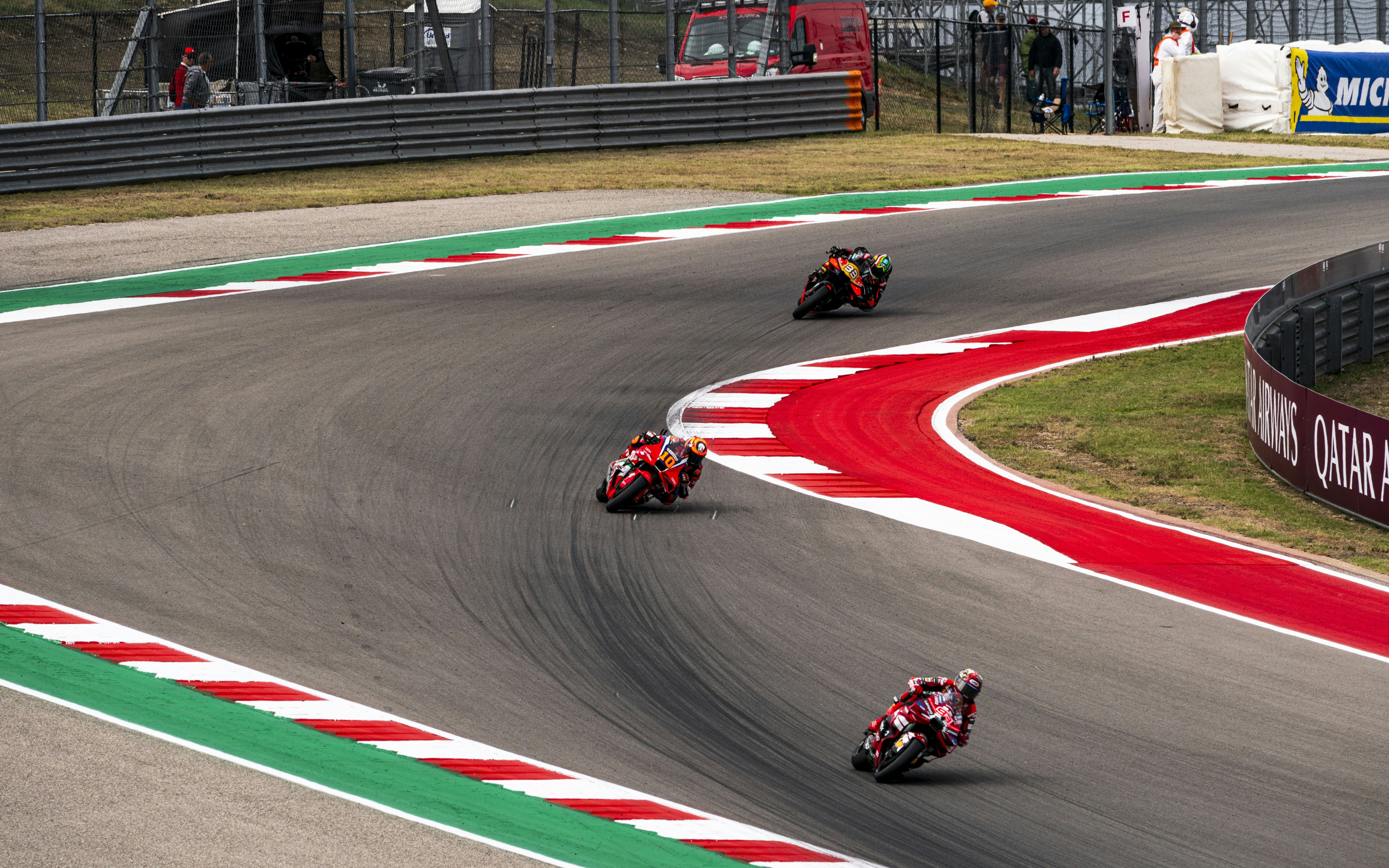 Aerial Turn: Riders Carve the Apex on Red‑And‑White Stripes