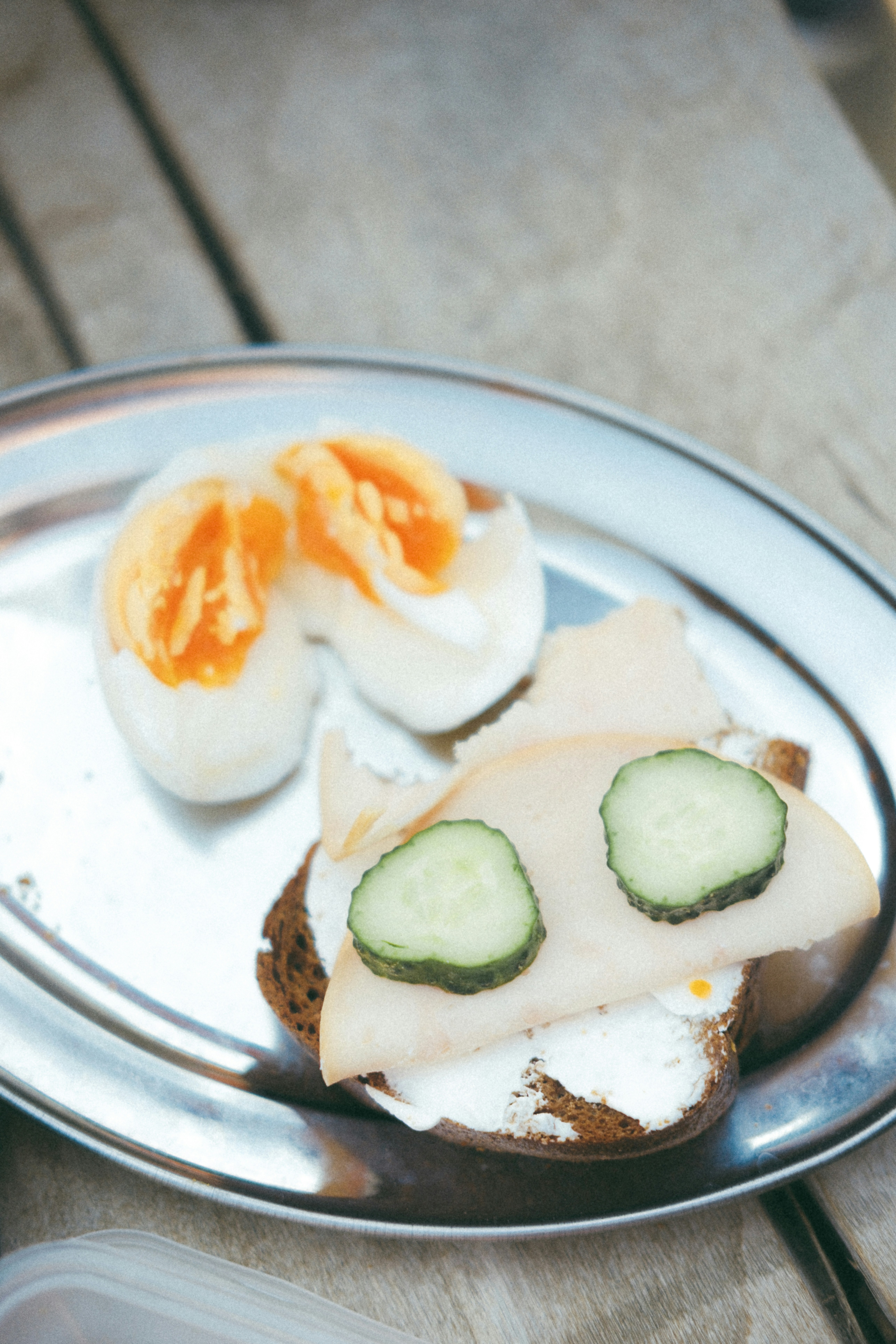 Cucumber-lit Sandwich on a Shiny Plate