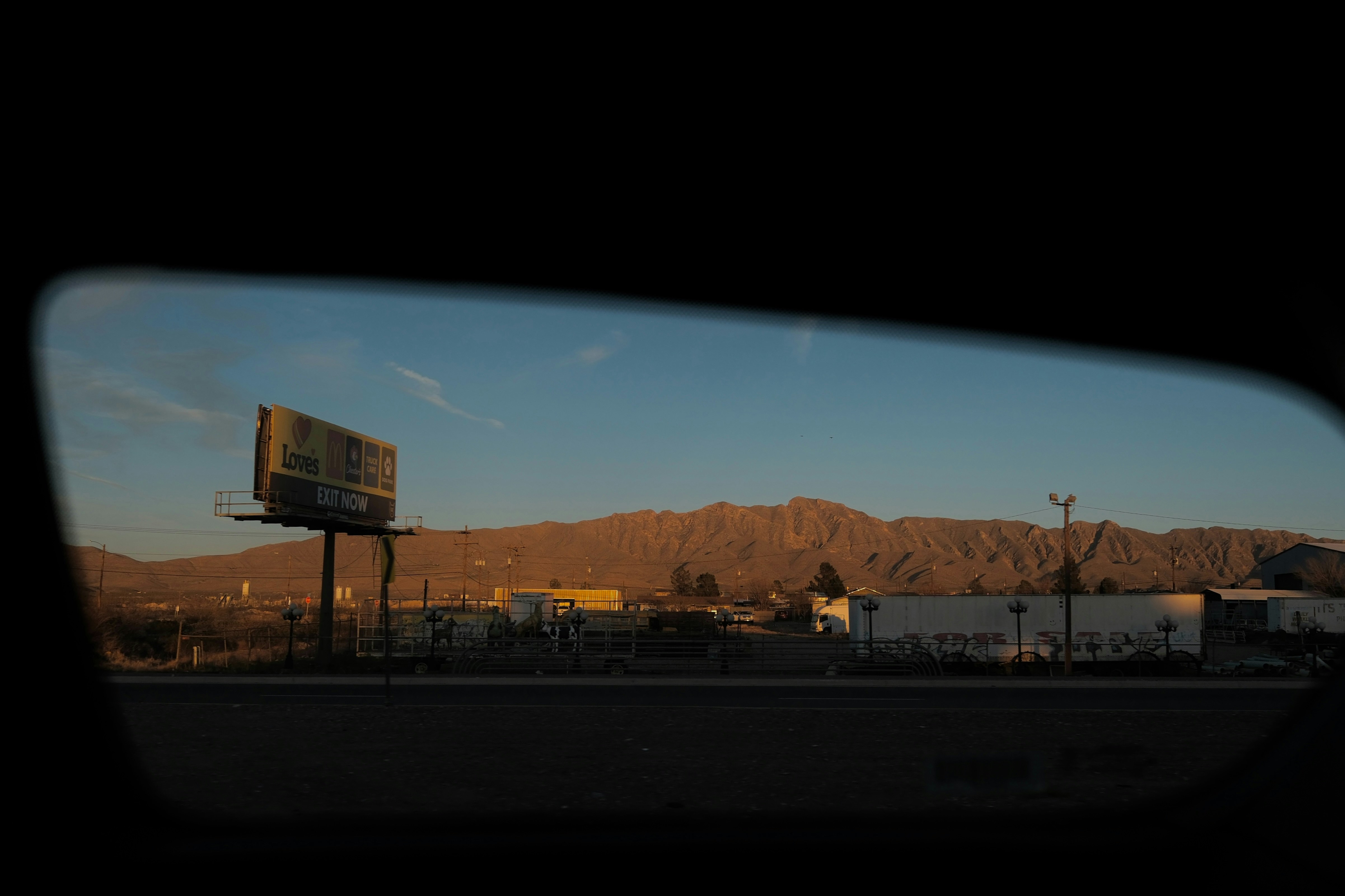 Desert Highway Horizon Framed by a Car Window Veil