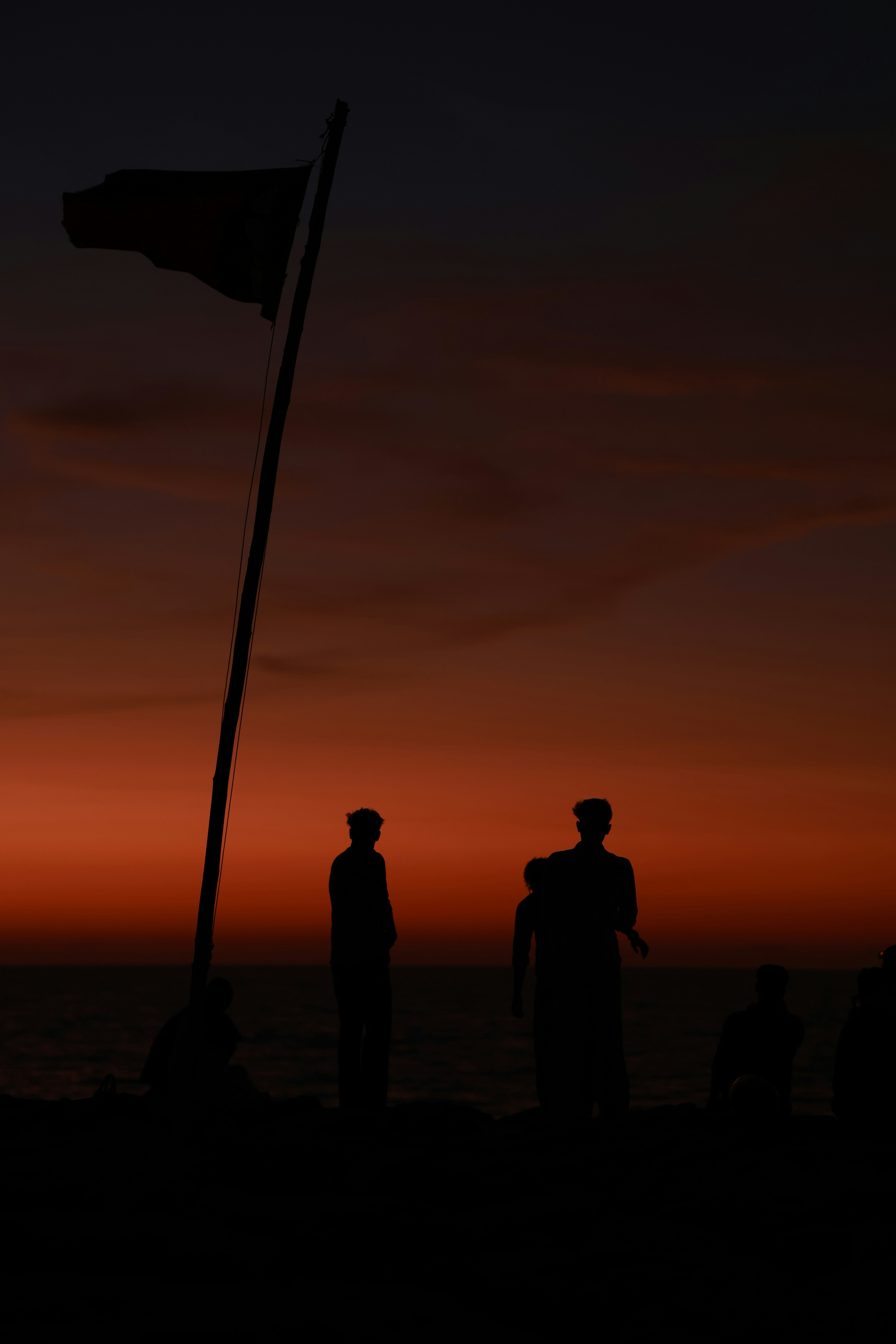 Silhouettes at Dusk: A Quiet Beach Constellation