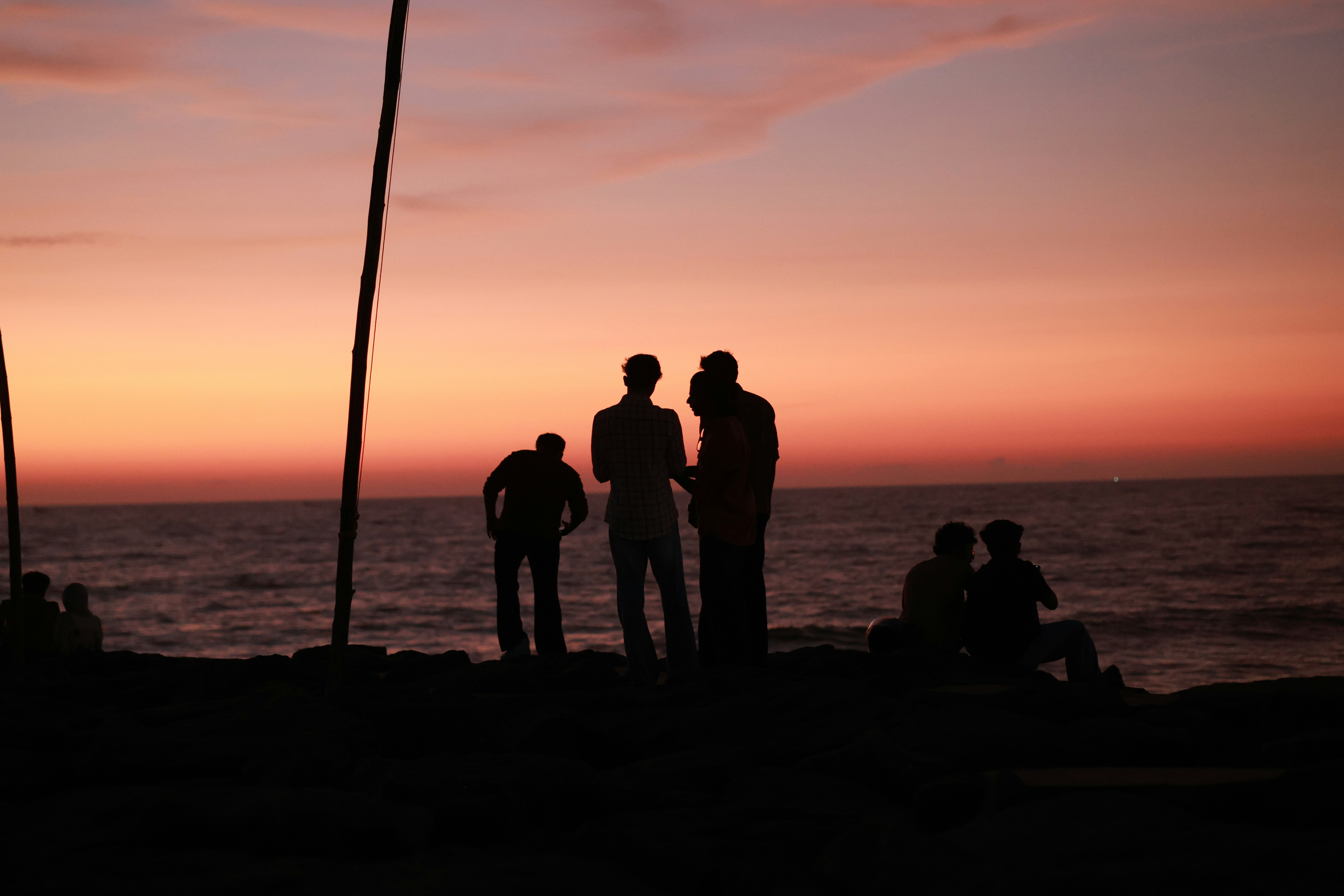 Sunset Silhouettes: A Contemplative shoreline Gathering