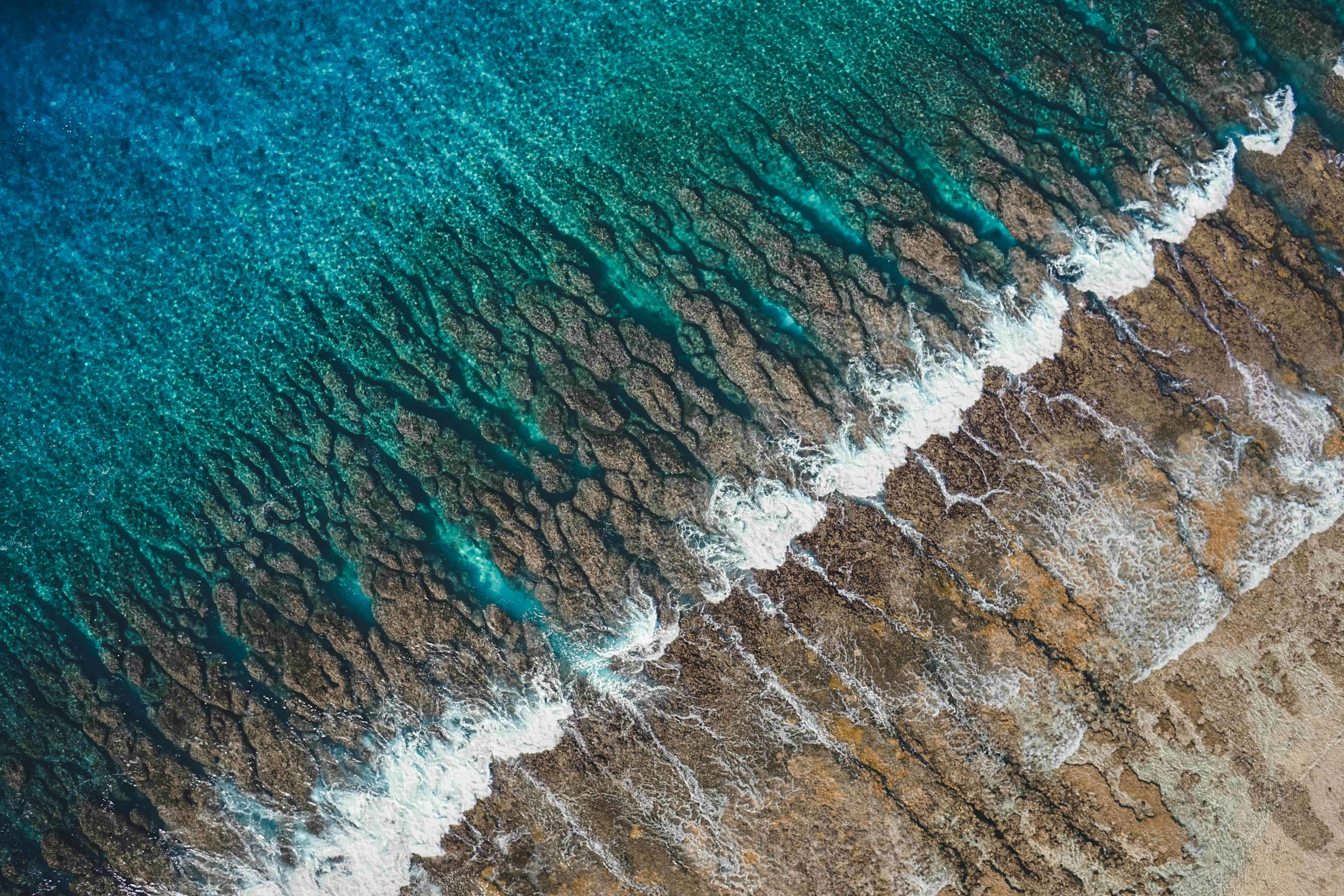 Azure Shorelines: Aerial Portrait of Waves Carving the Sand