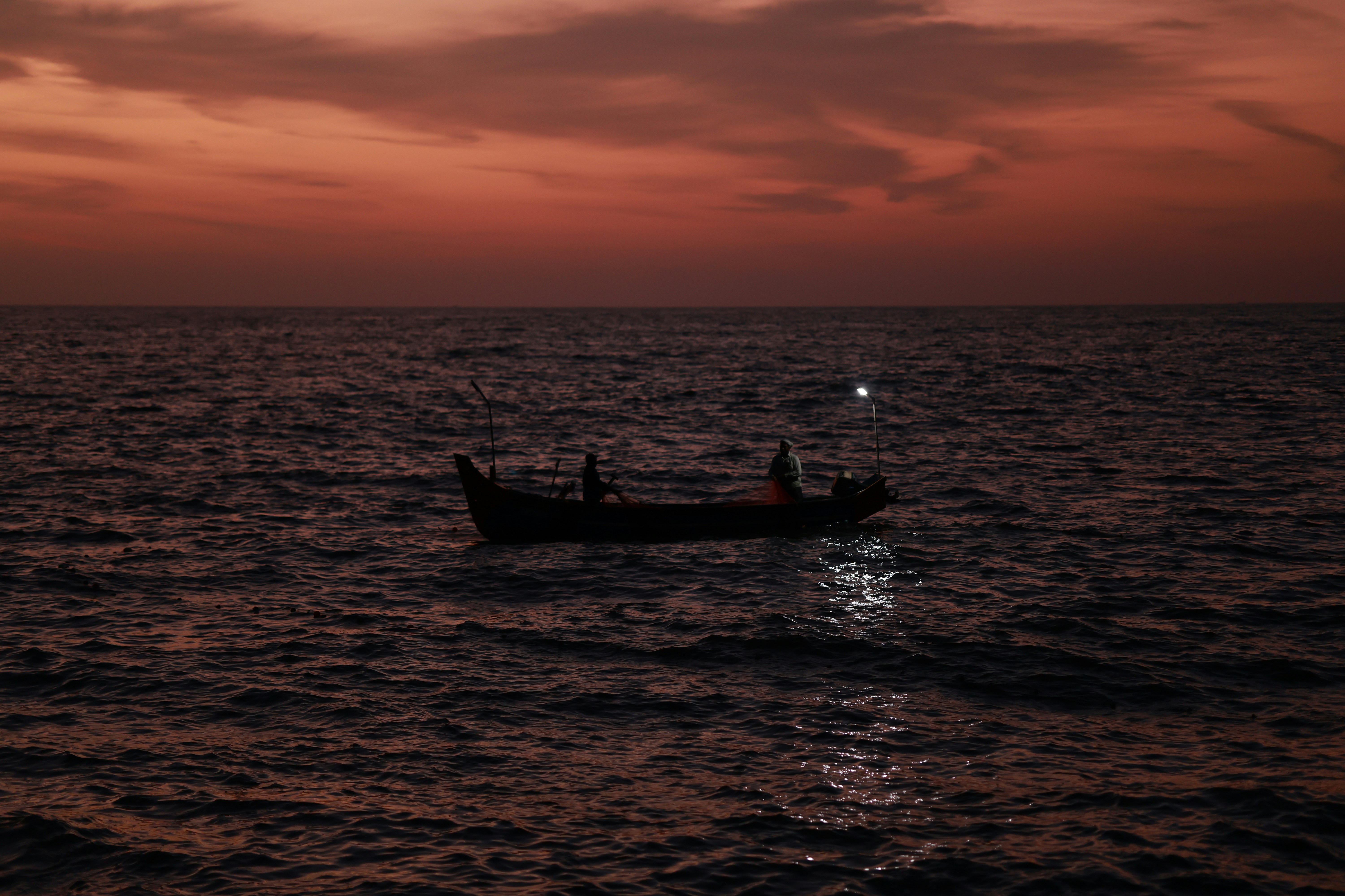 Distant Boat under a Crimson Sea