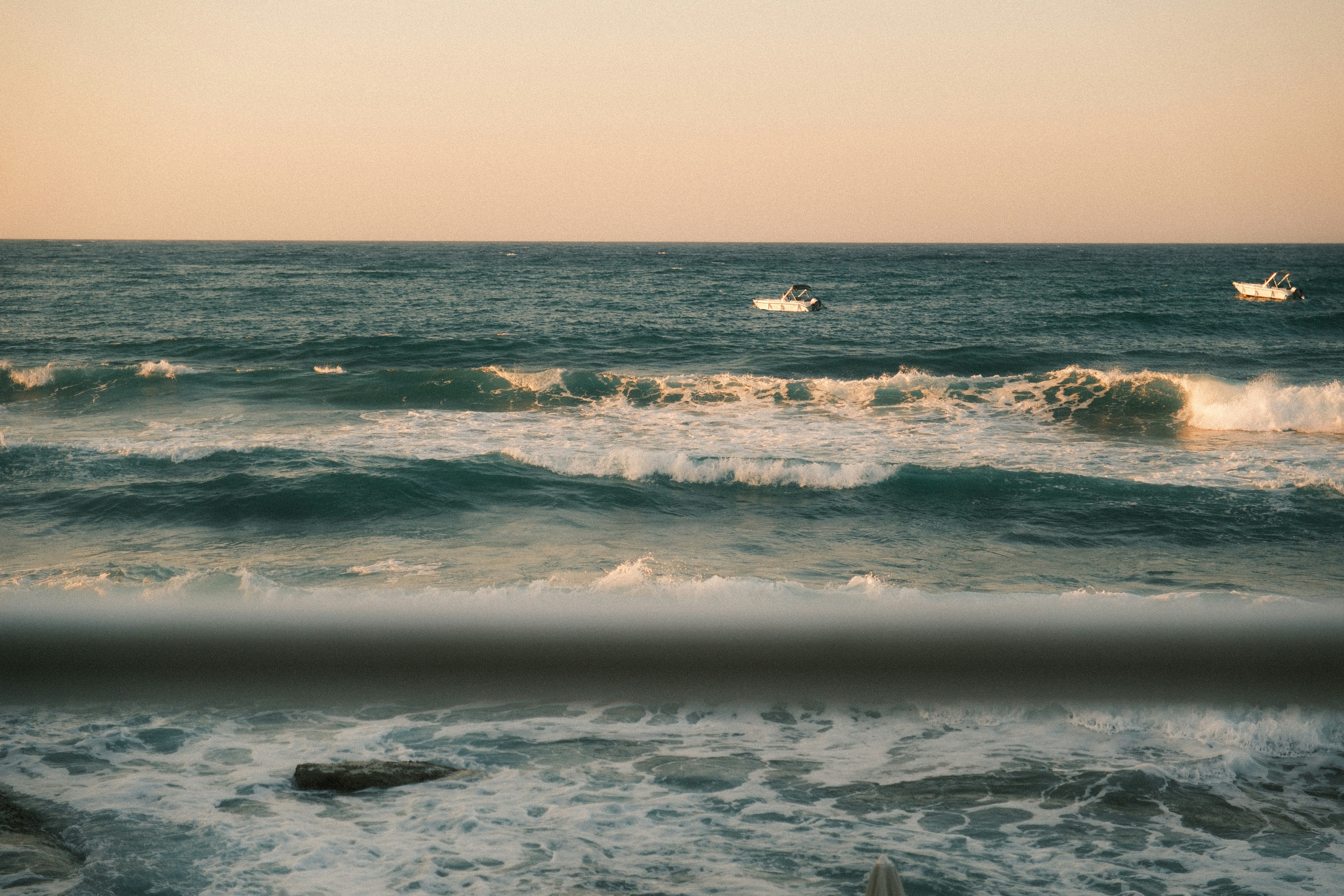 Horizon in Focus: Boats Tread the Quiet Sea