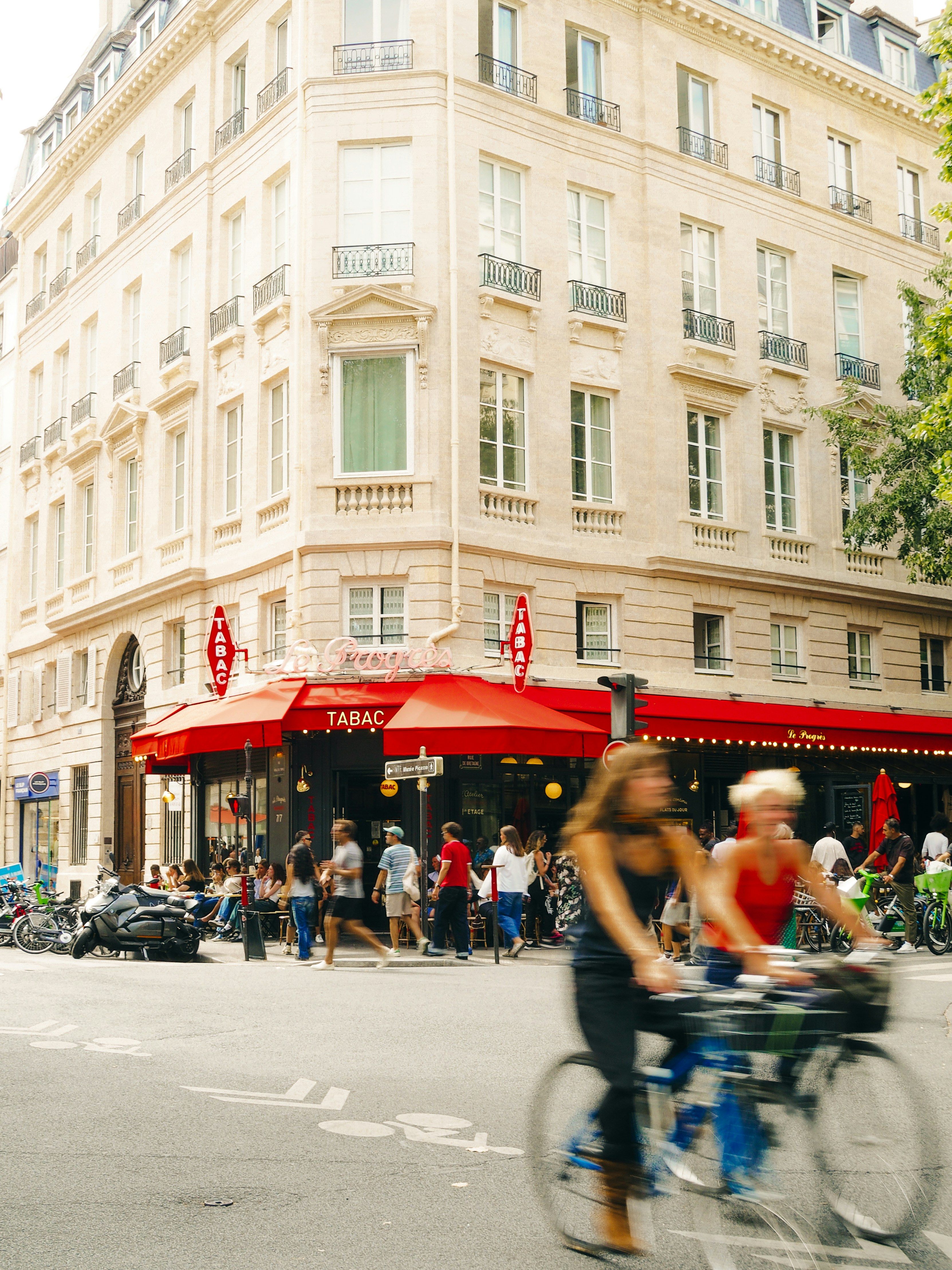 Parisian Corner Café Under a Red Canopy