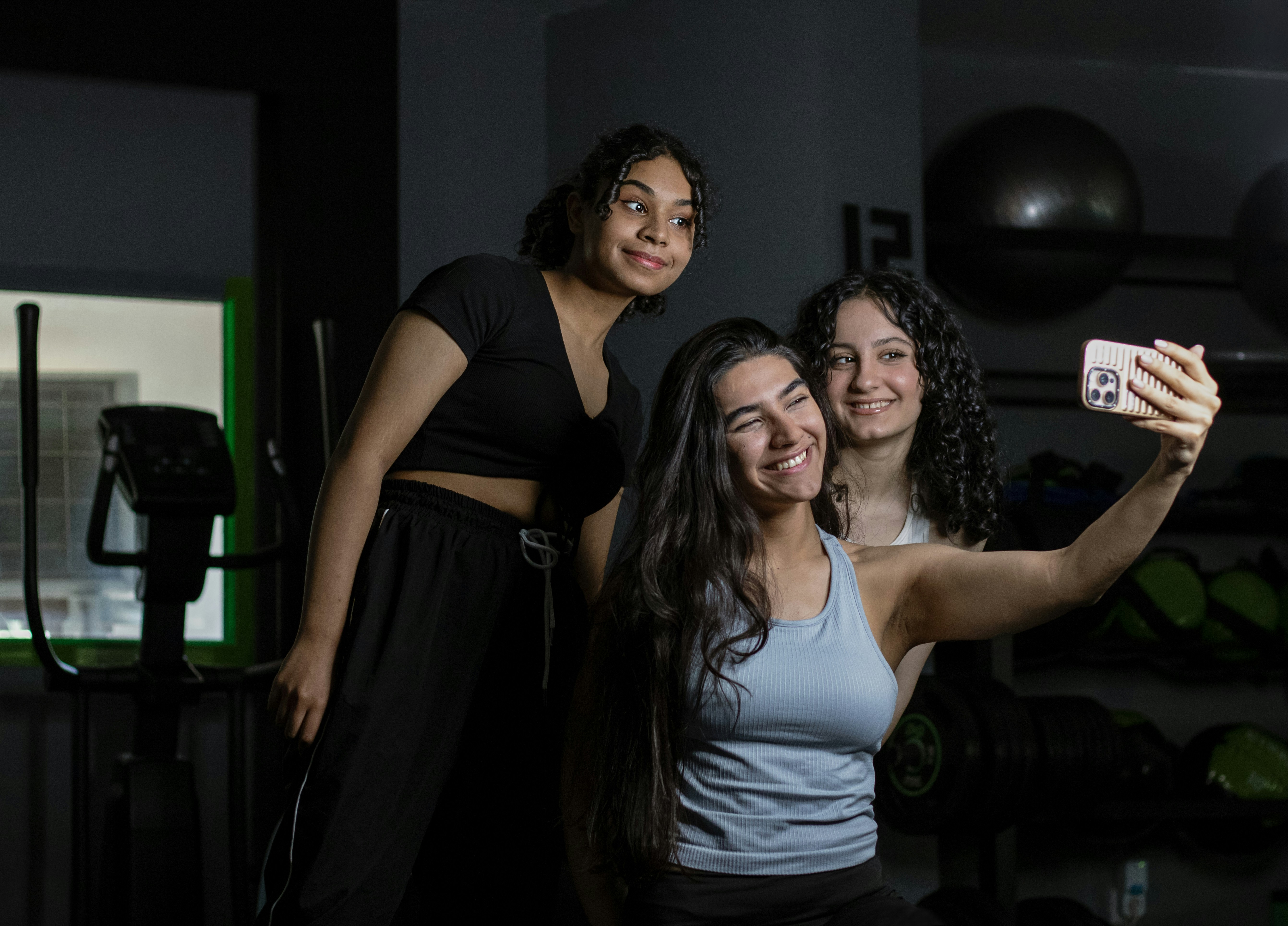Selfie in the Gym: Trio Captures a Candid Laugh