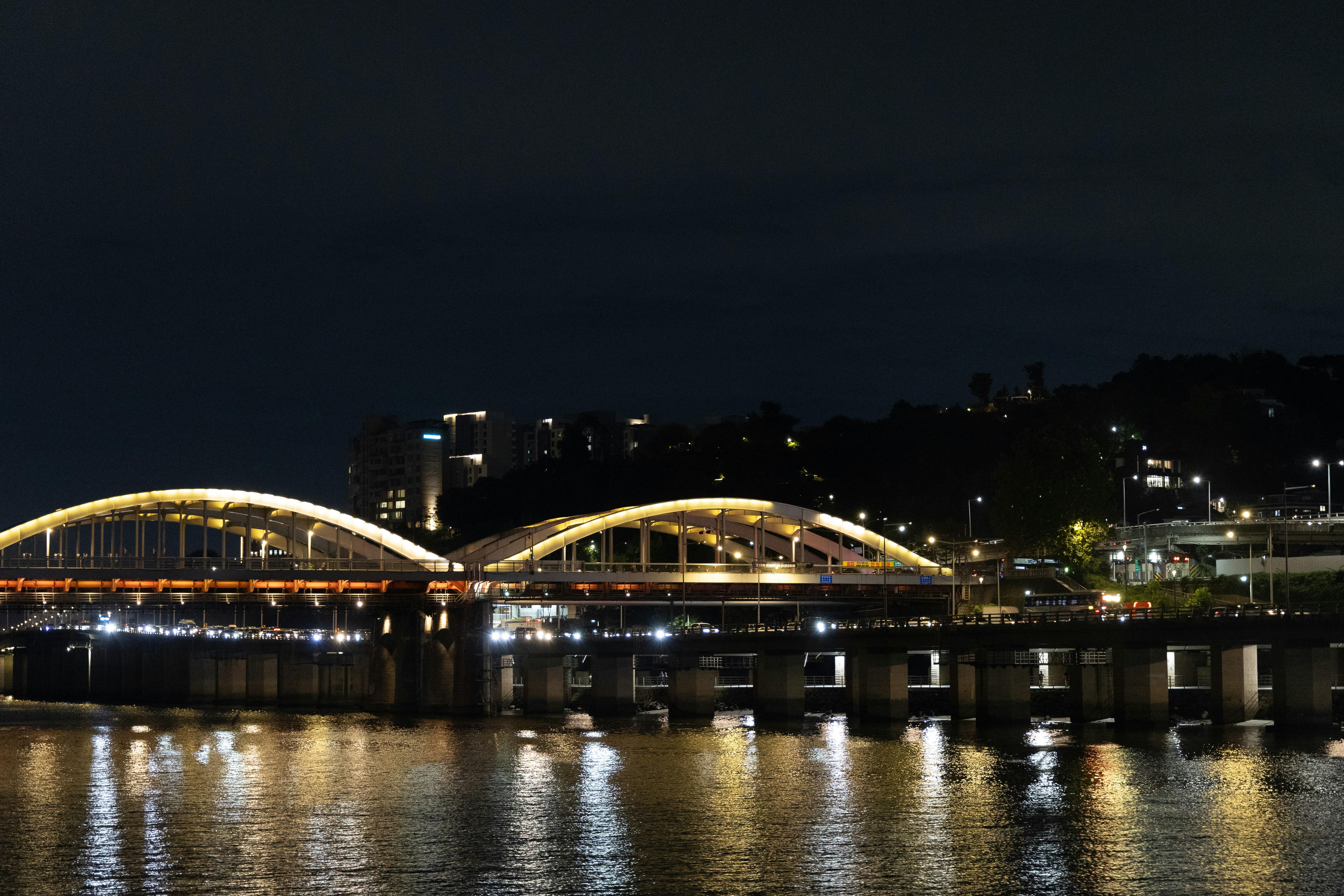 Twin-arched Night Bridge Bathing in City Lights