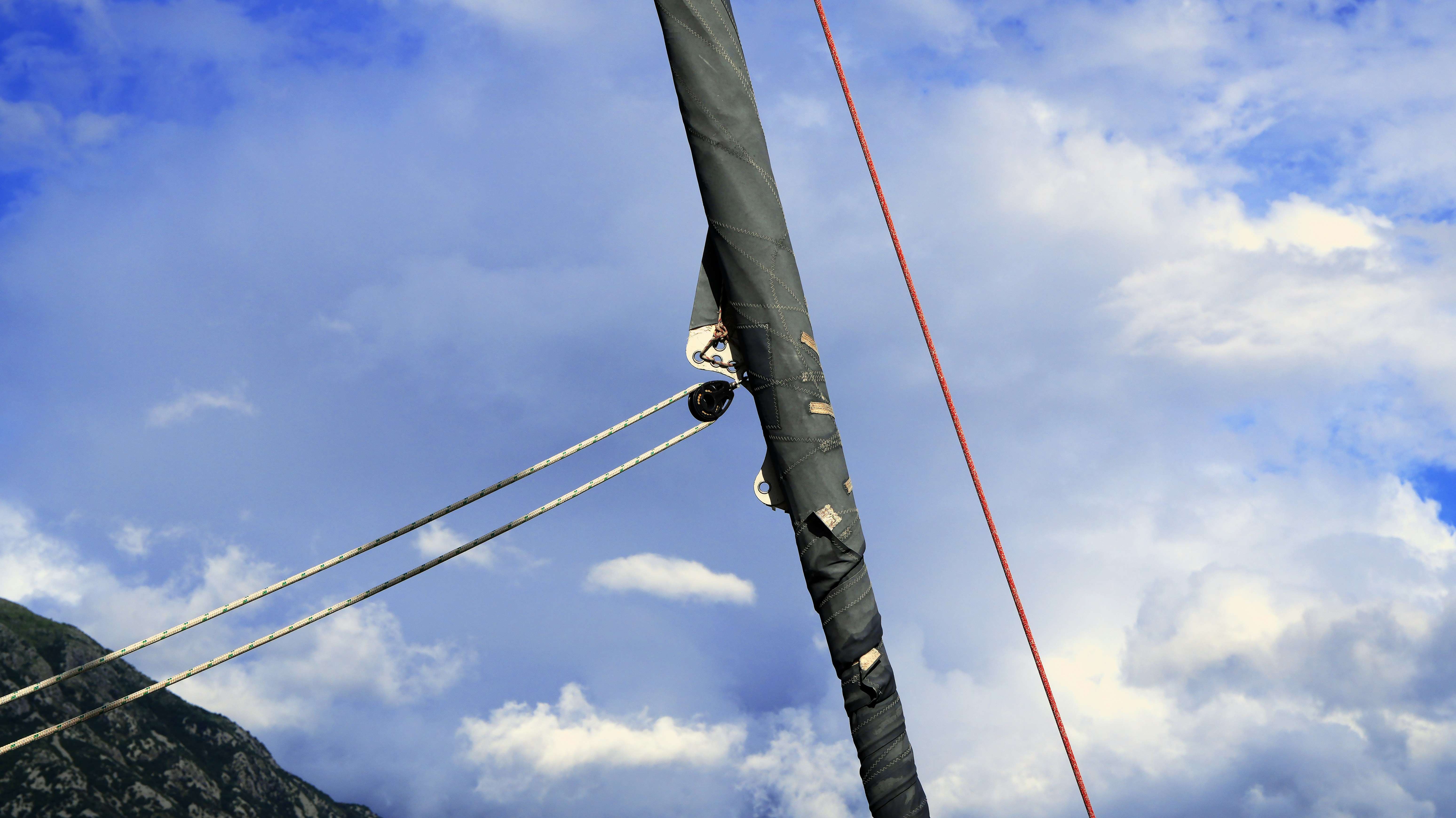 Ridge Sail: A Mast and Cables Cut Across a Sky-Blue Crest