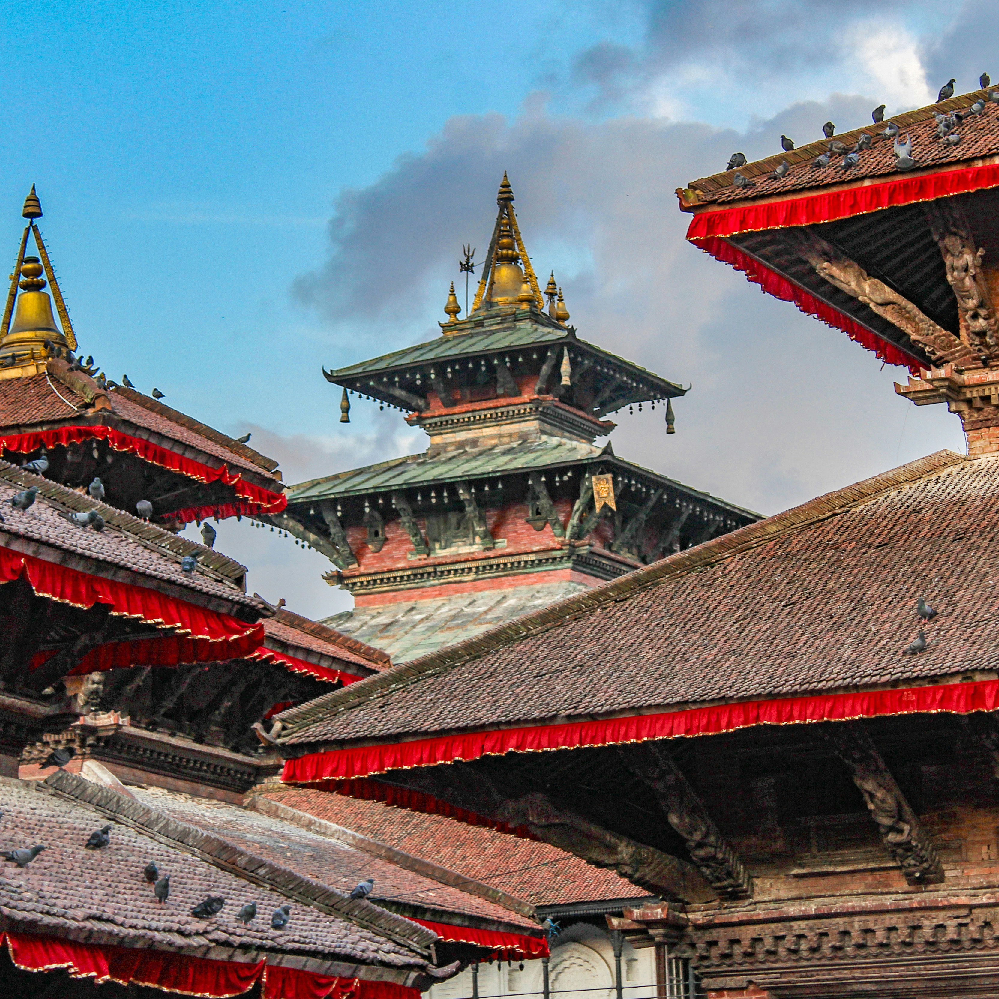 Temple Peaks Above the Red-Tiered Roofs in Kathmandu's Ancient Quarter