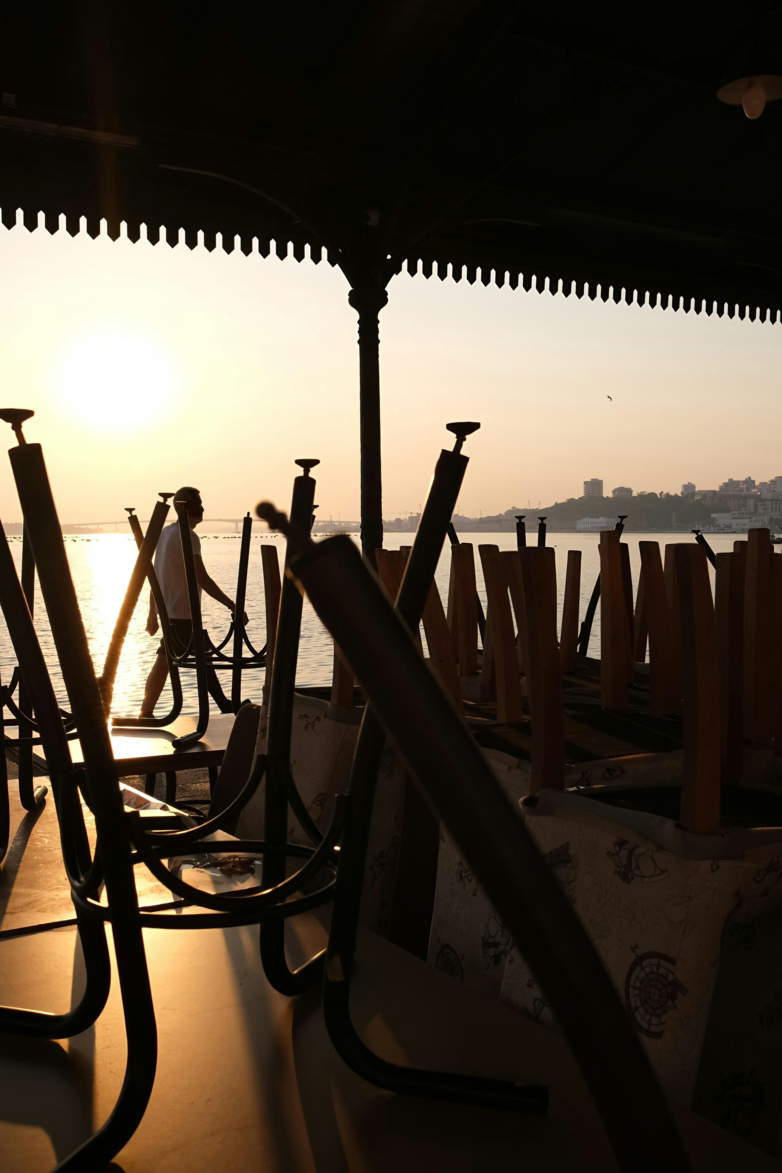 Sunset Silhouettes at the Pier: Chairs, Rails, and Stanchions in Quiet Twilight