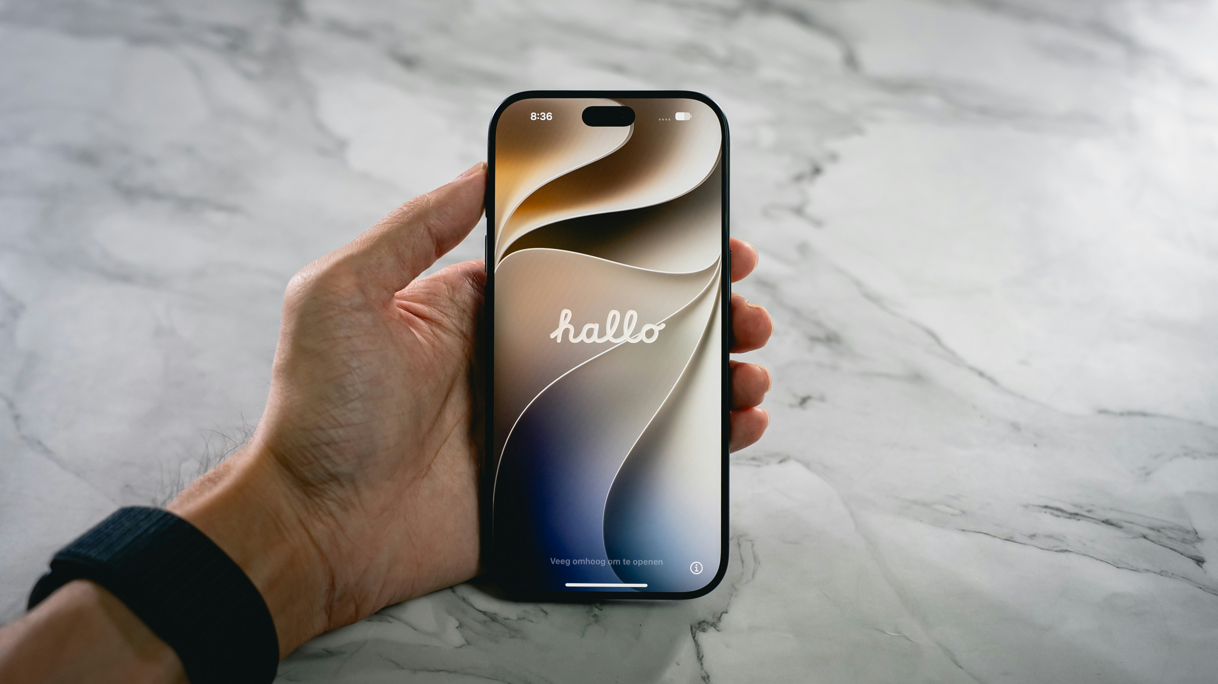 Hello in Focus: A Hand-Held iPhone Leaning into Marble Light