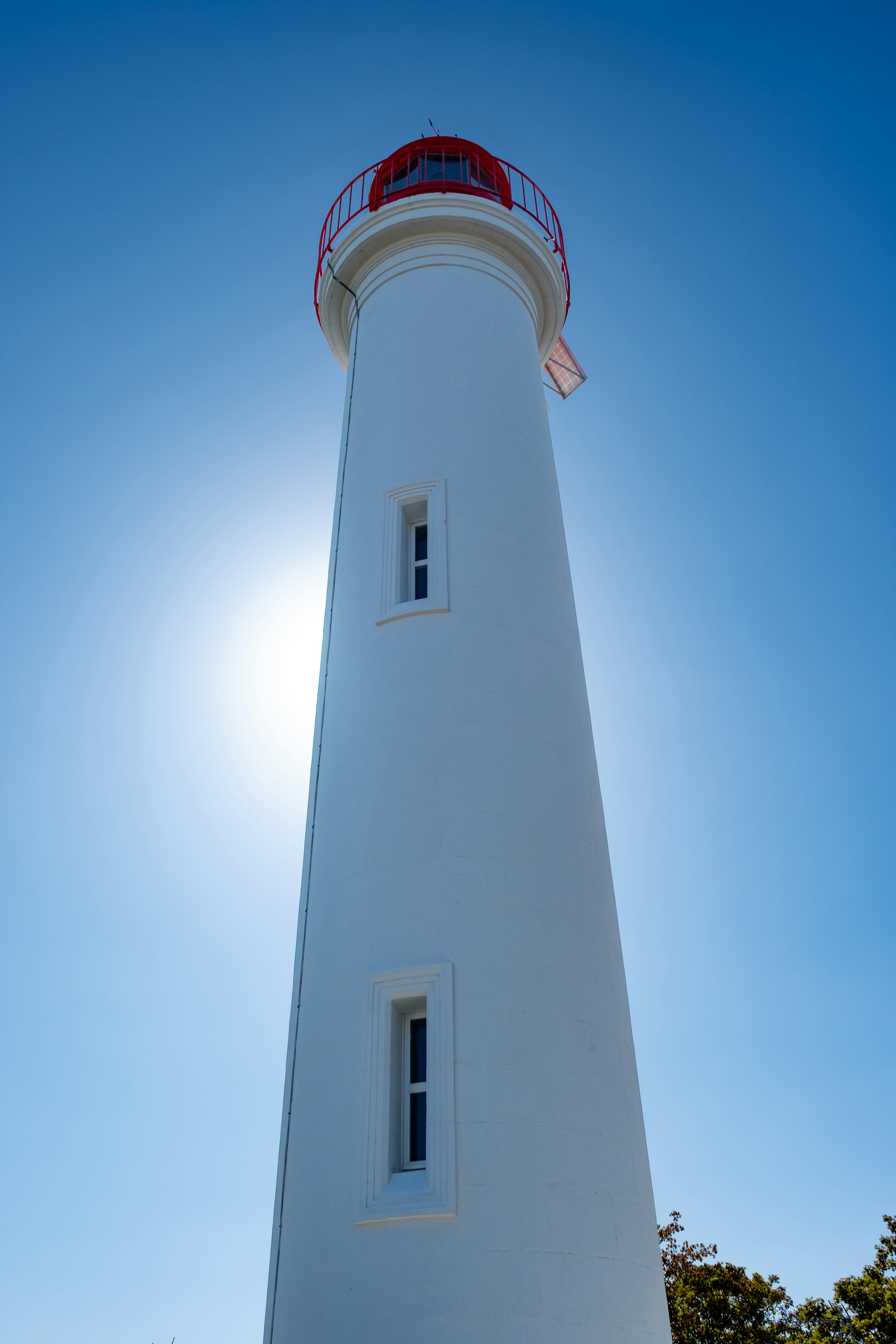 Skyward Beacon: A White Lighthouse Reaching for the Blue