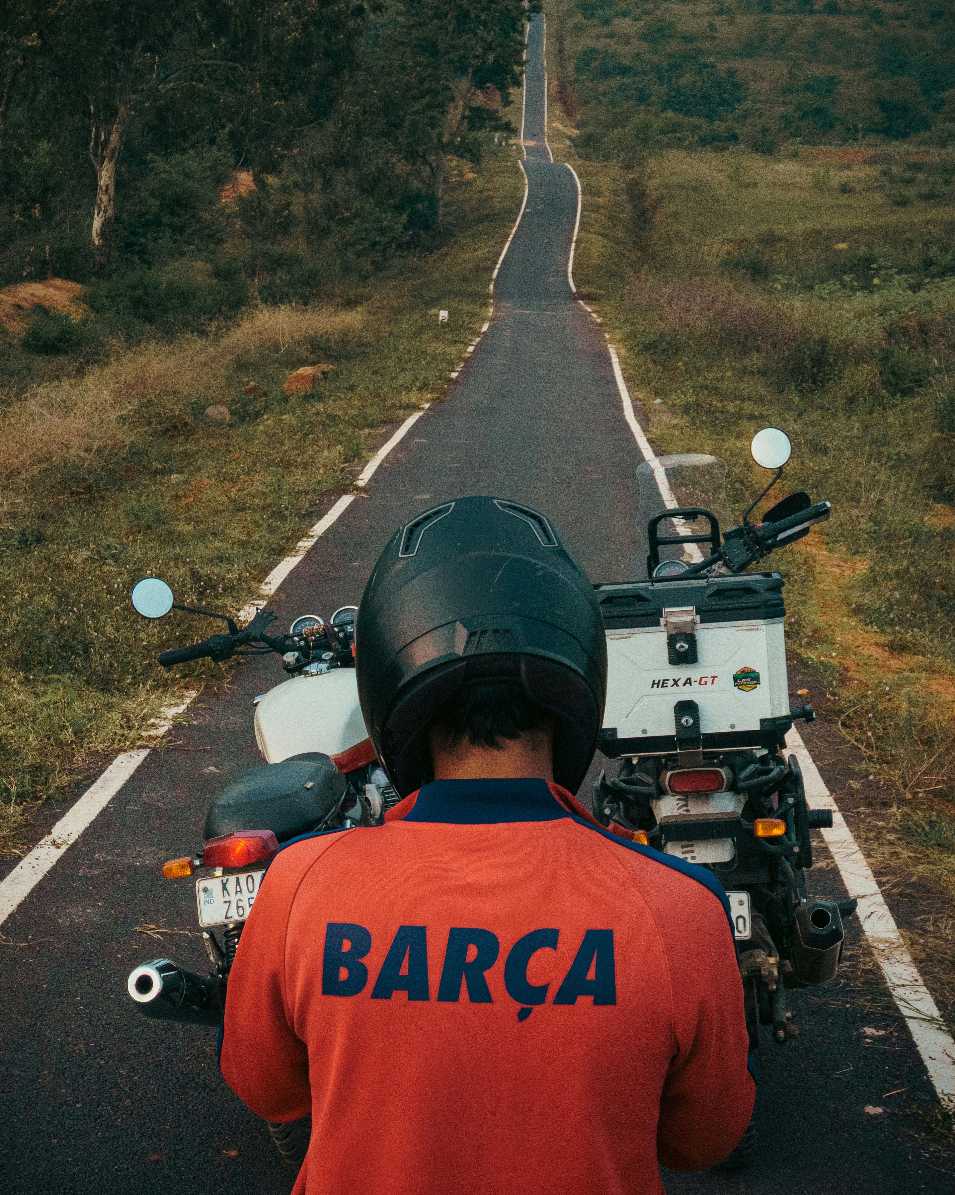 Backlit Rider in a Long Stretch: A Barça Jersey on a Quiet Road