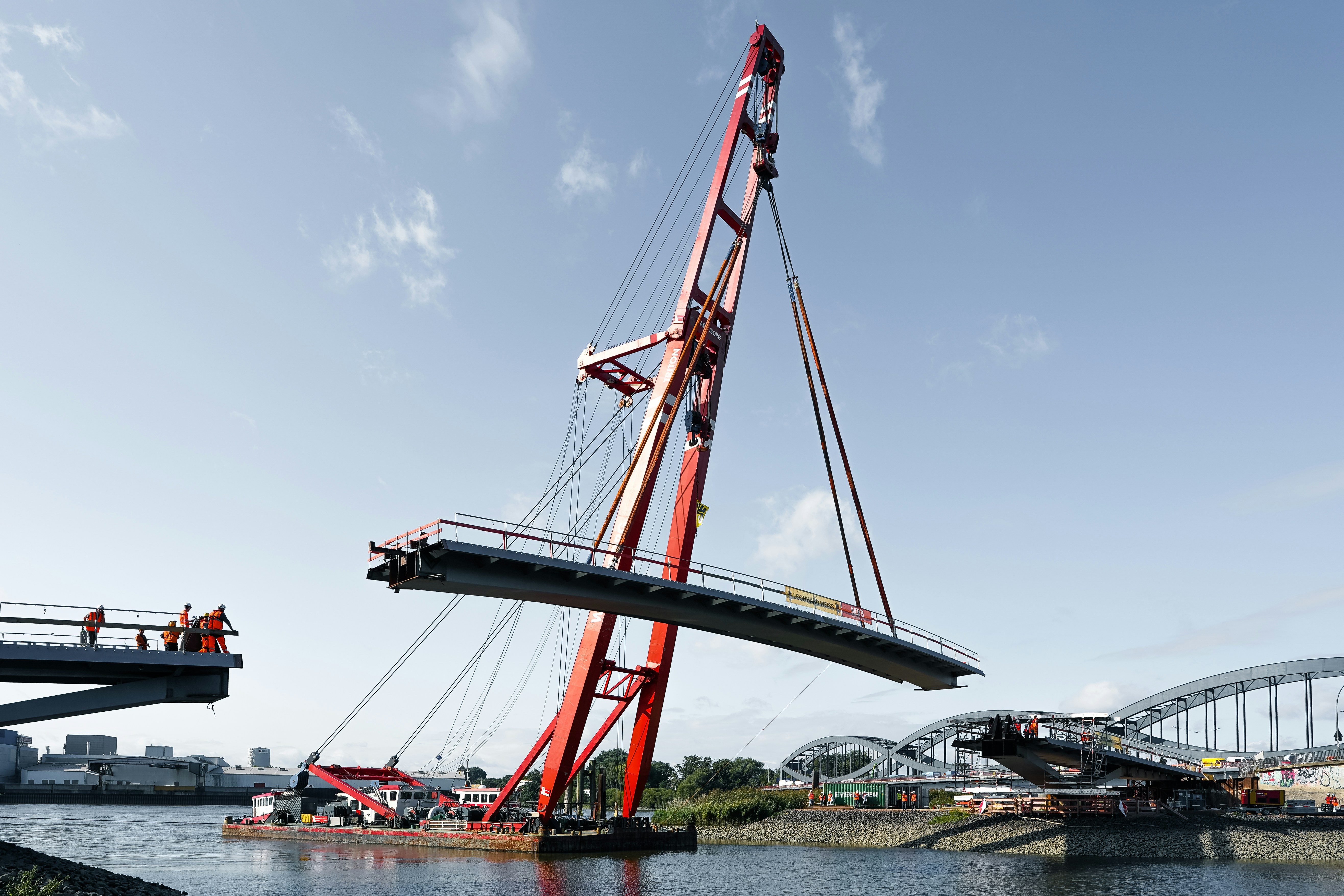 Bridge on the Thames: A red girder lifts into a clear sky