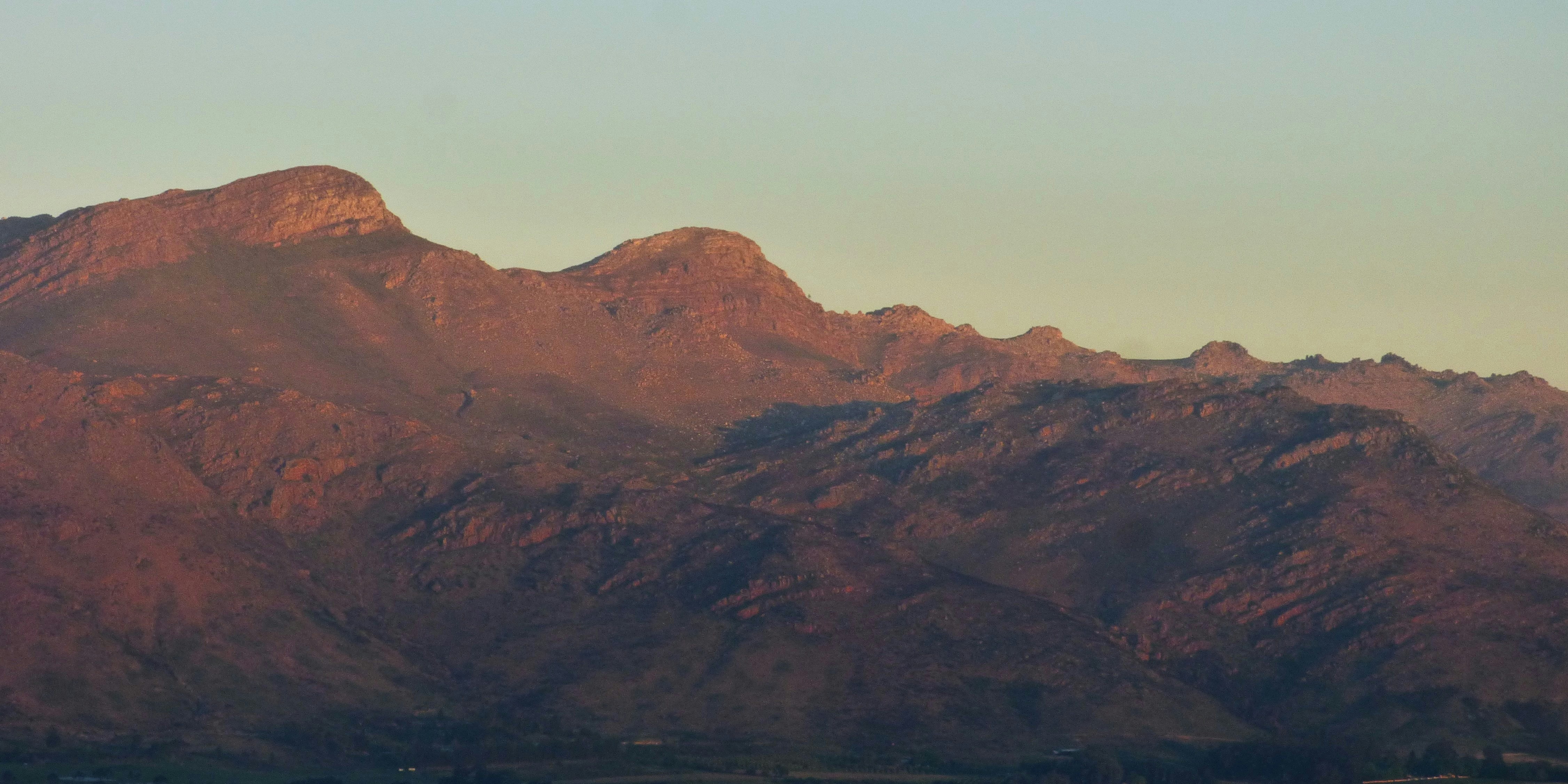 Sunlit Ridge at Dusk Over Quiet Valleys