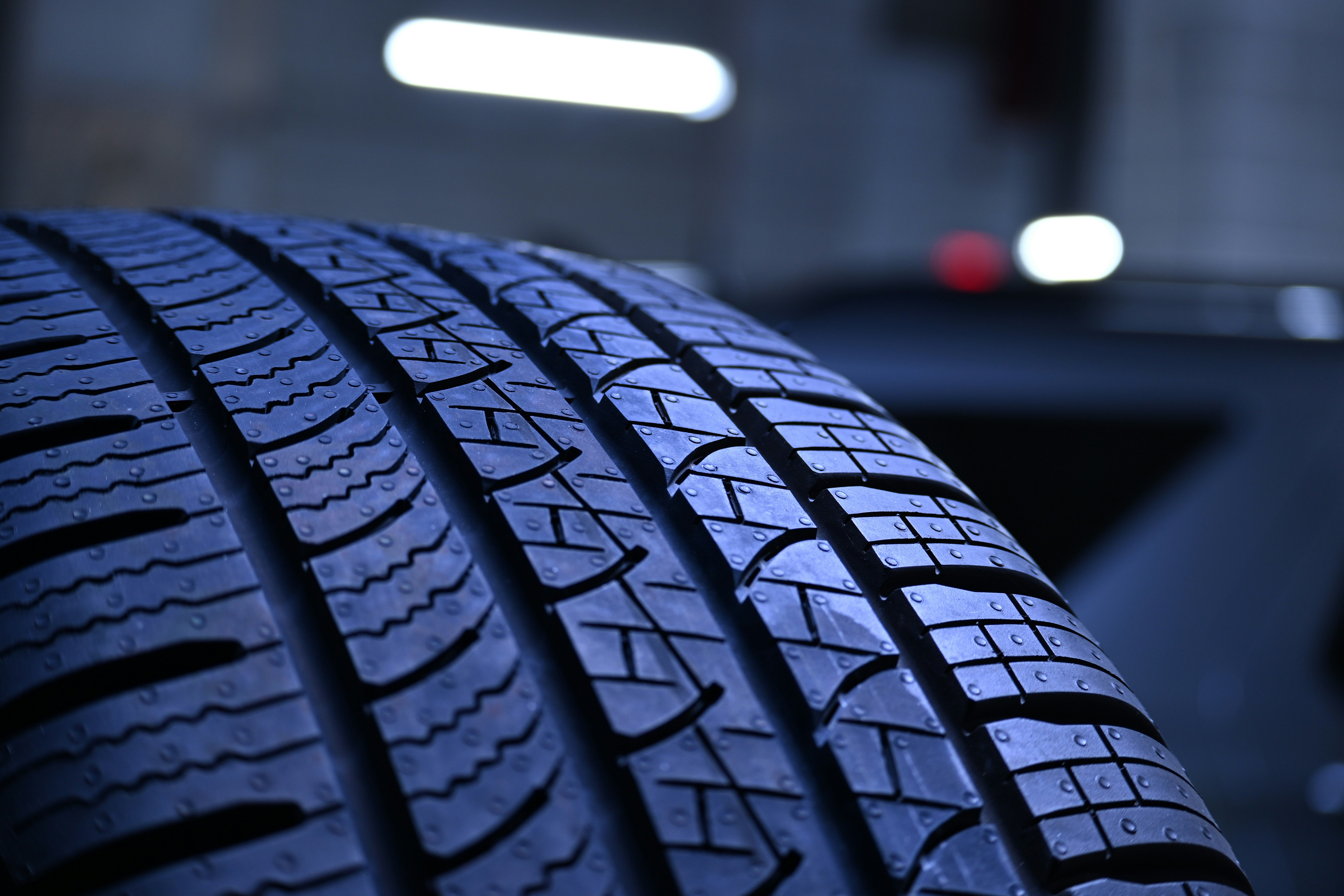 Close-Up of a Winter Tire Tread Under Soft Urban Night Lights