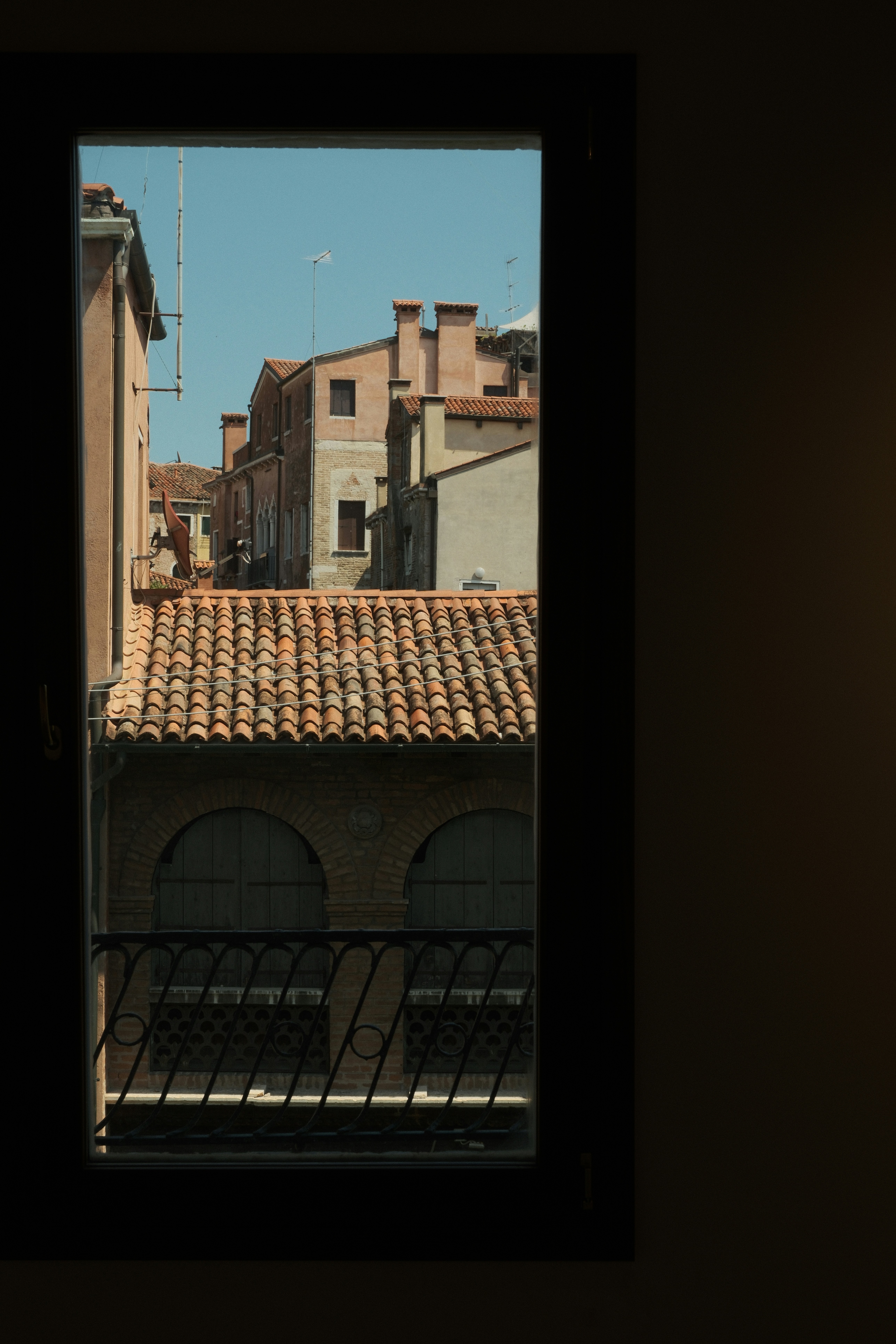 City Rooftops Through a Narrow Window