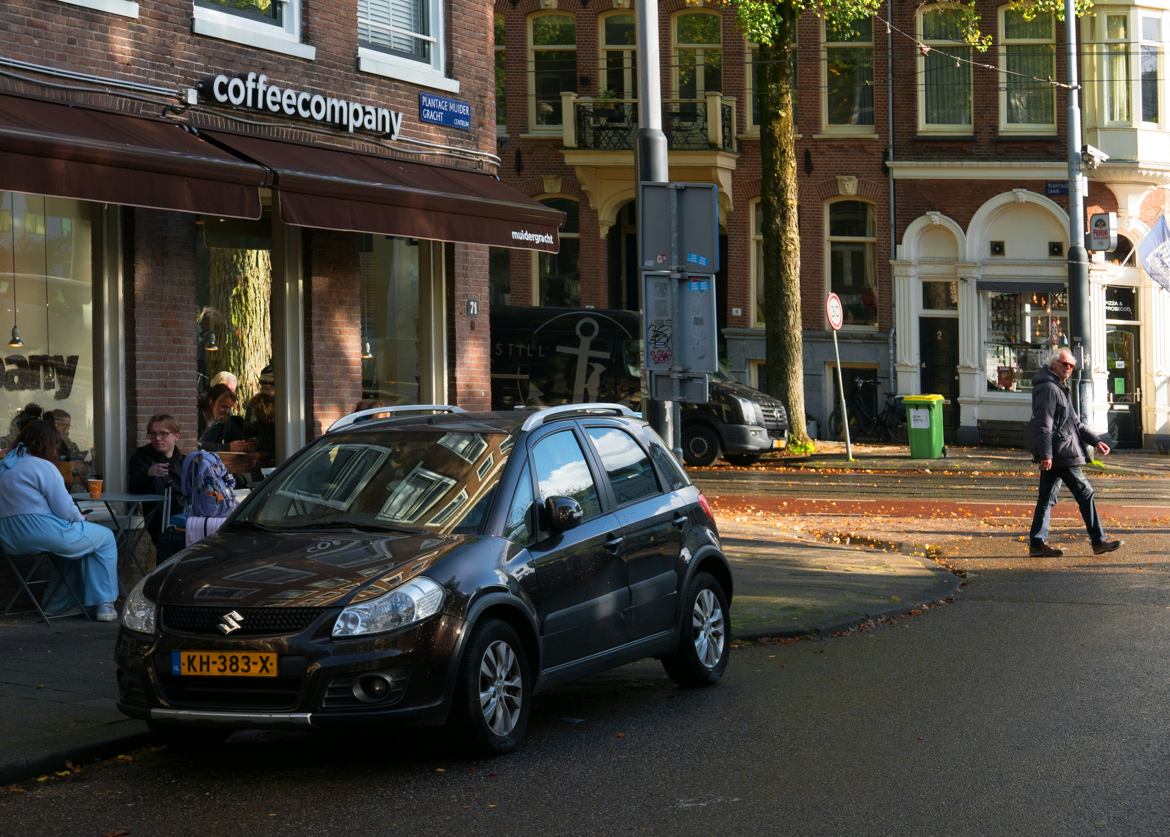 City Street Spotlight: A Compact Suzuki Anchors the Sidewalk Scene