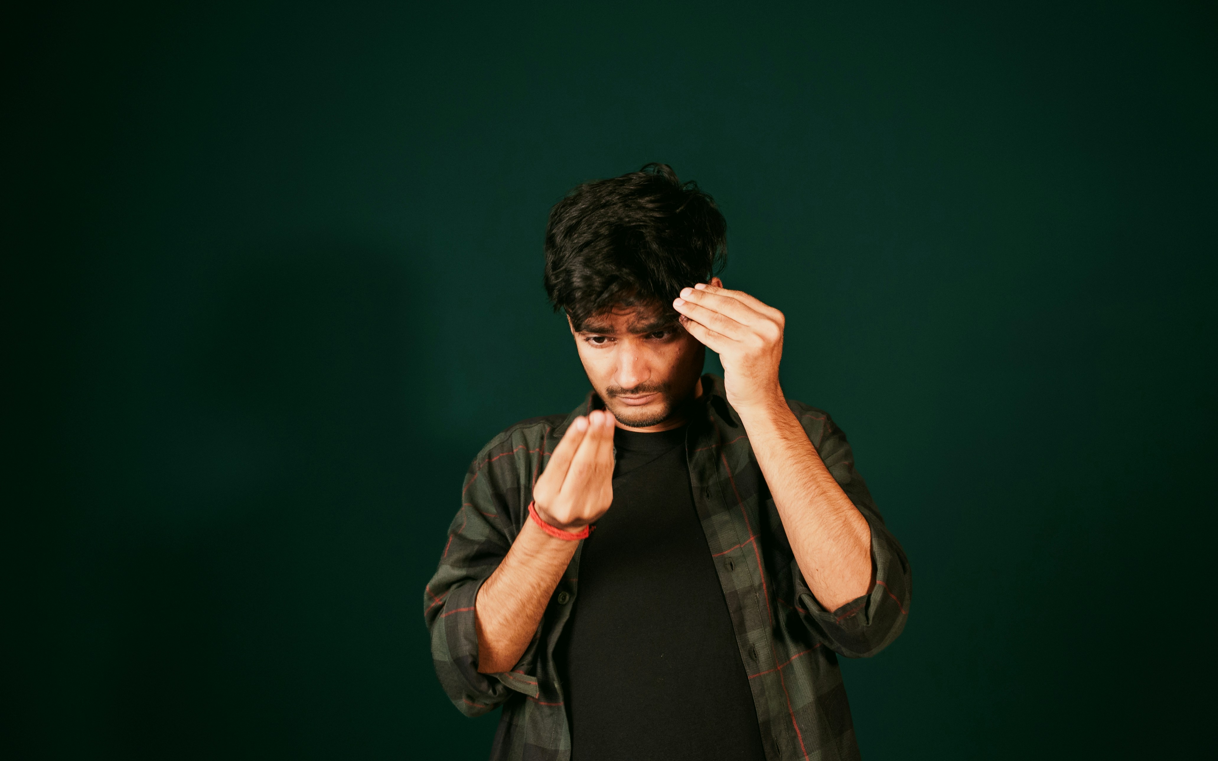 Mid-Tone Focus: A Thoughtful Moment in a Dark Green Studio