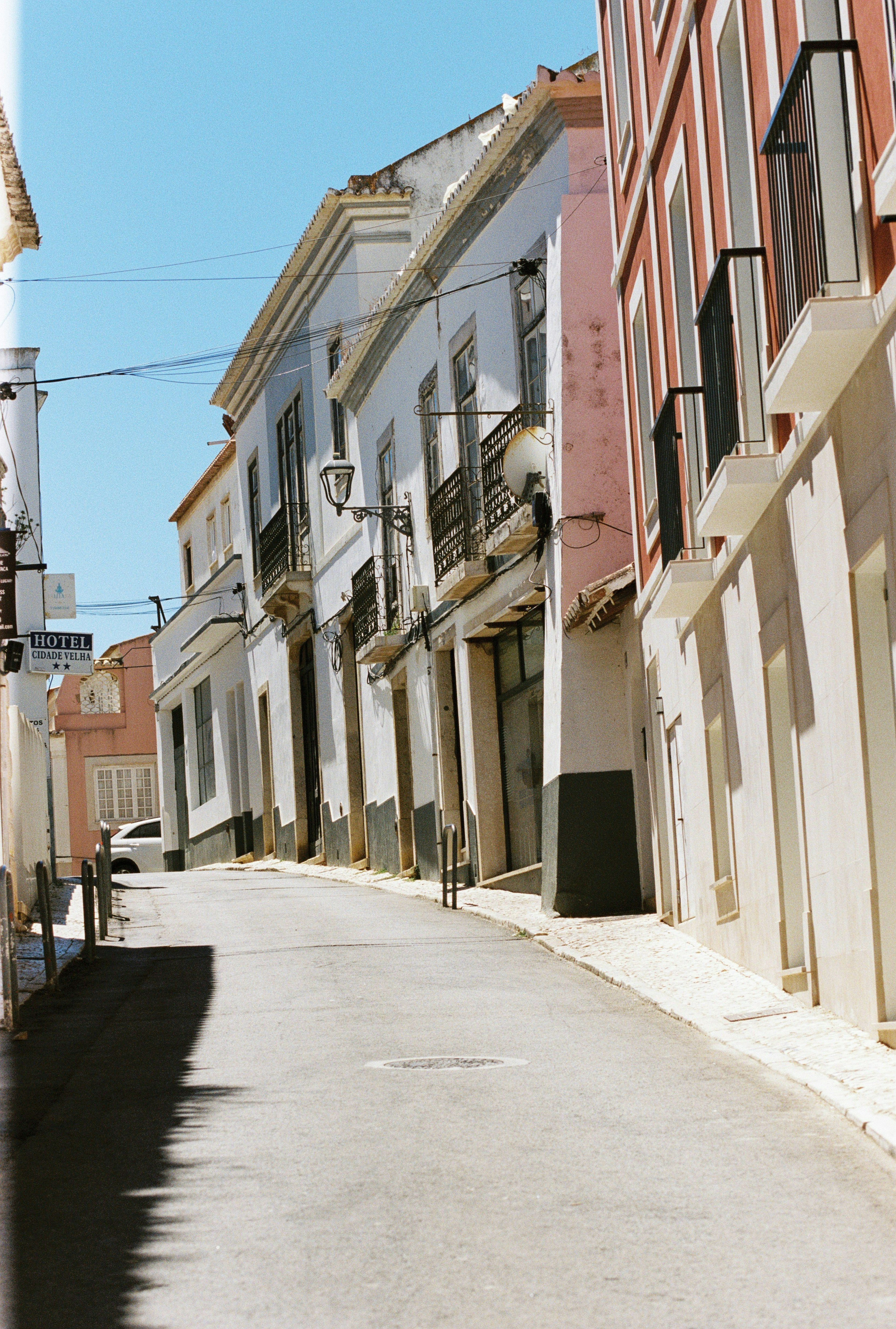 Sunlit Street of Multicolored Facades