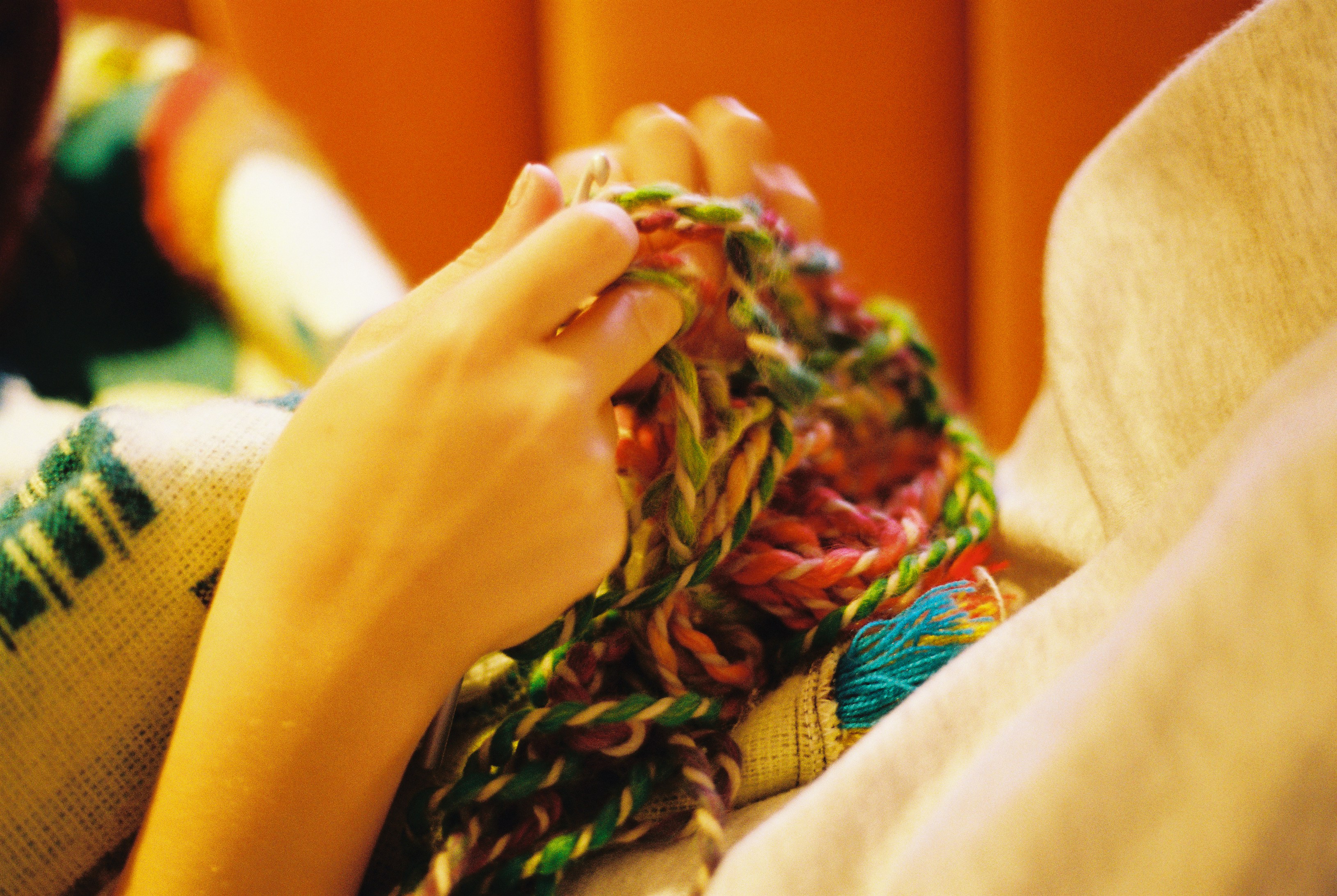 Fiber in Focus: Hands Weaving Colorful Threads