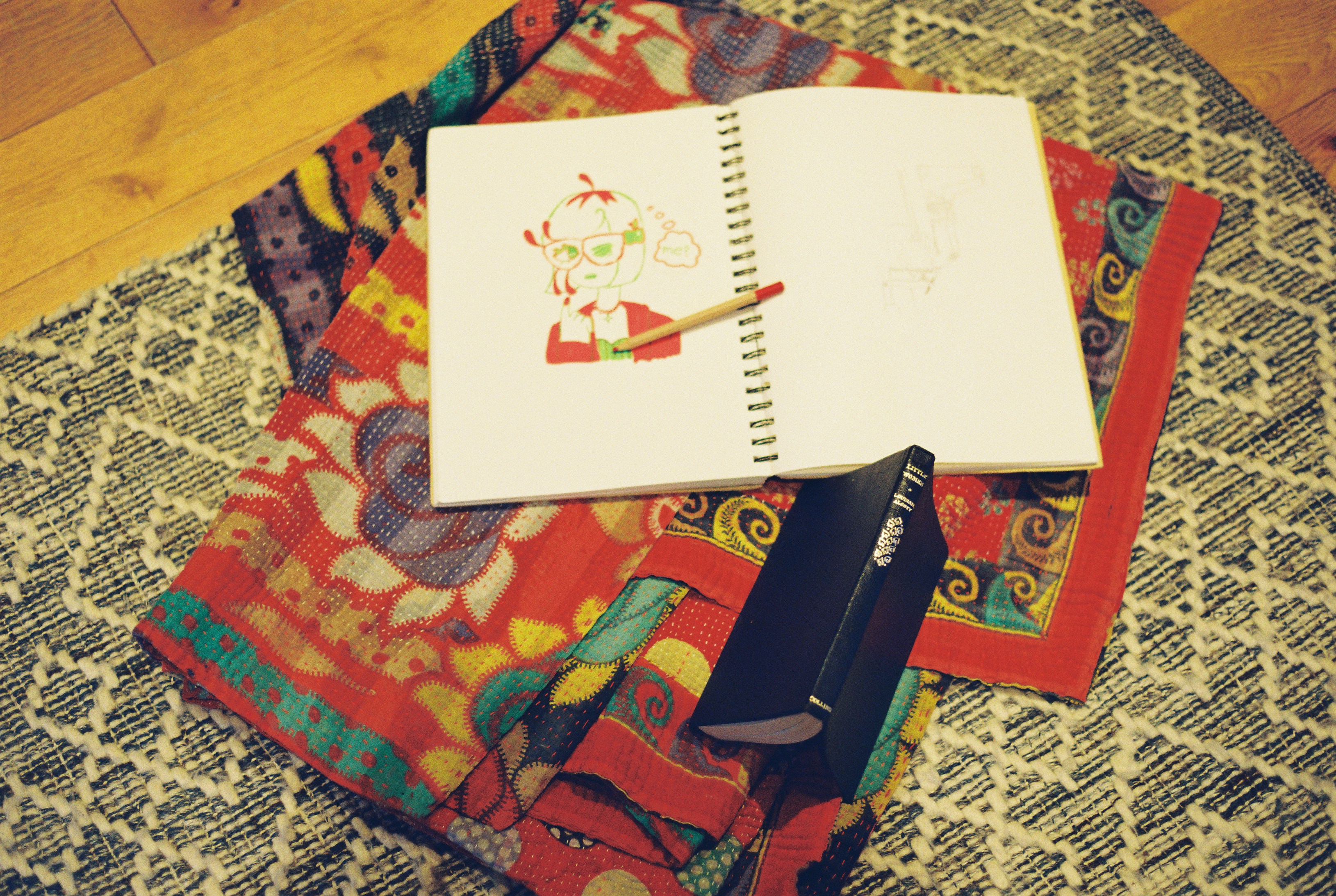 Sketchbook on a Patchwork Mat: A Quiet Moment with Color and Pencil