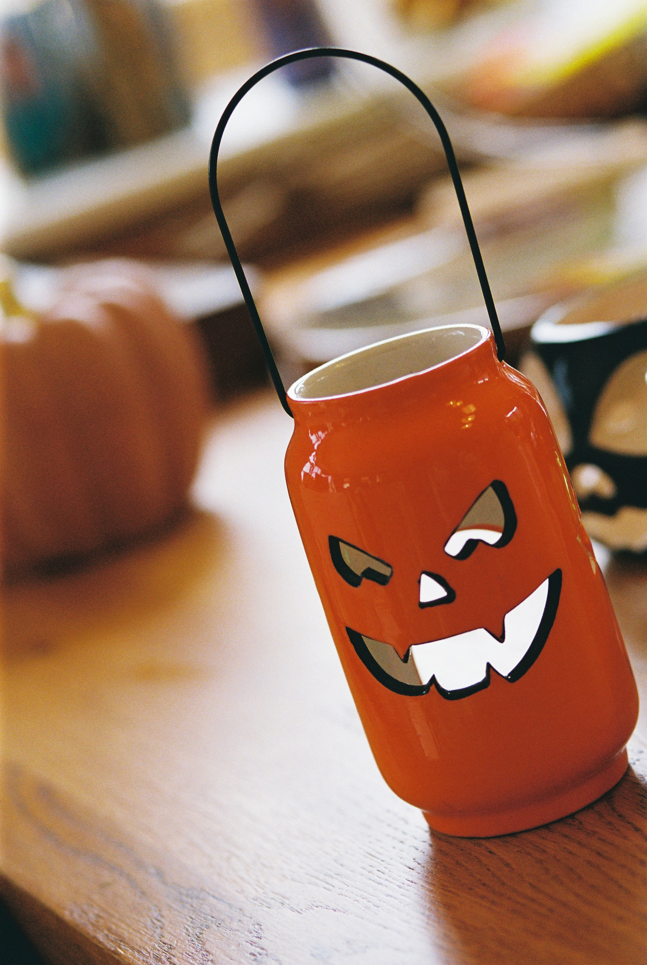 Pumpkin Days: A Jack-o’-Lantern Bottle on a Warm Wooden Table