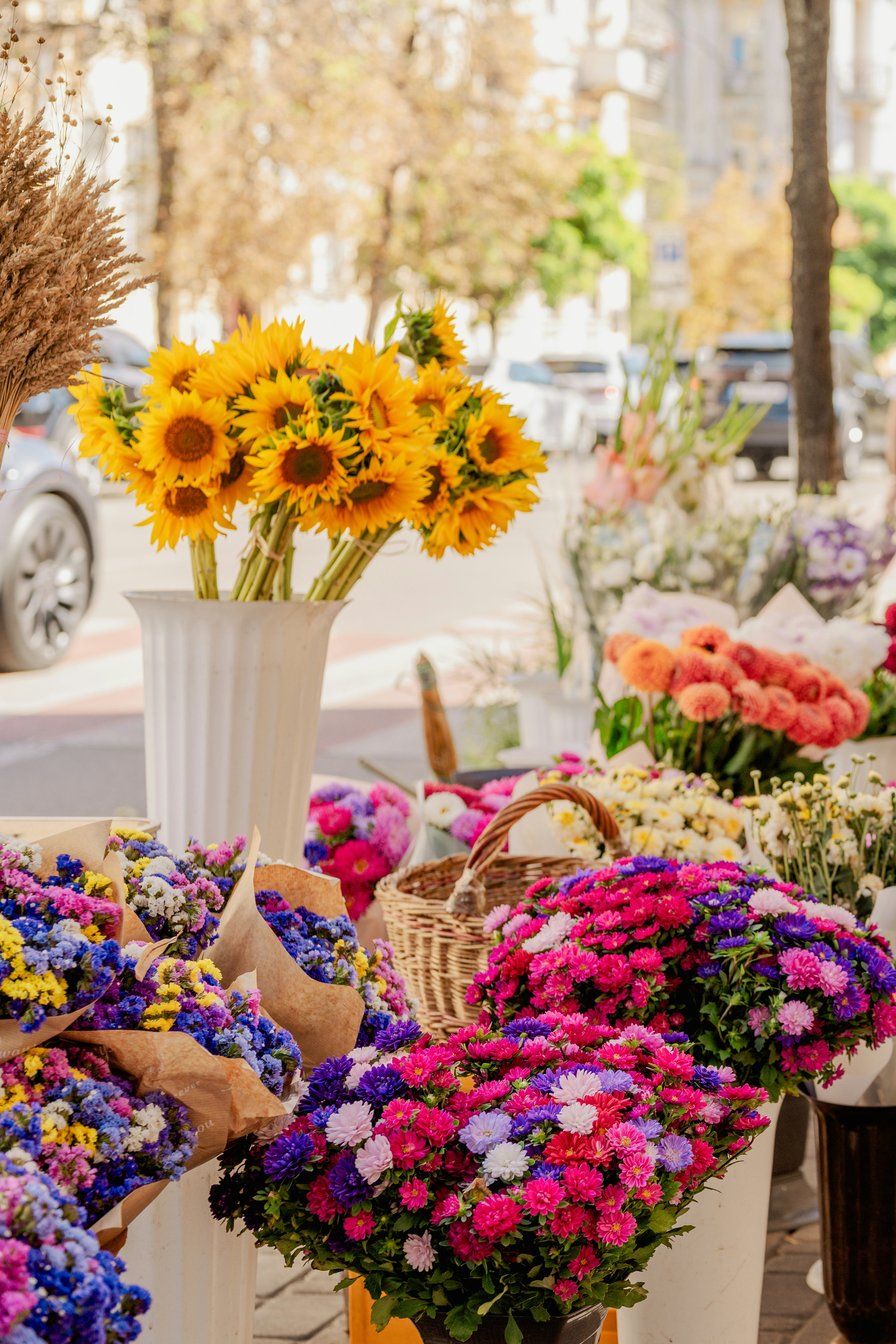 Sunlit Still Life: A Burst of Sunflowers Among Colorful Blooms