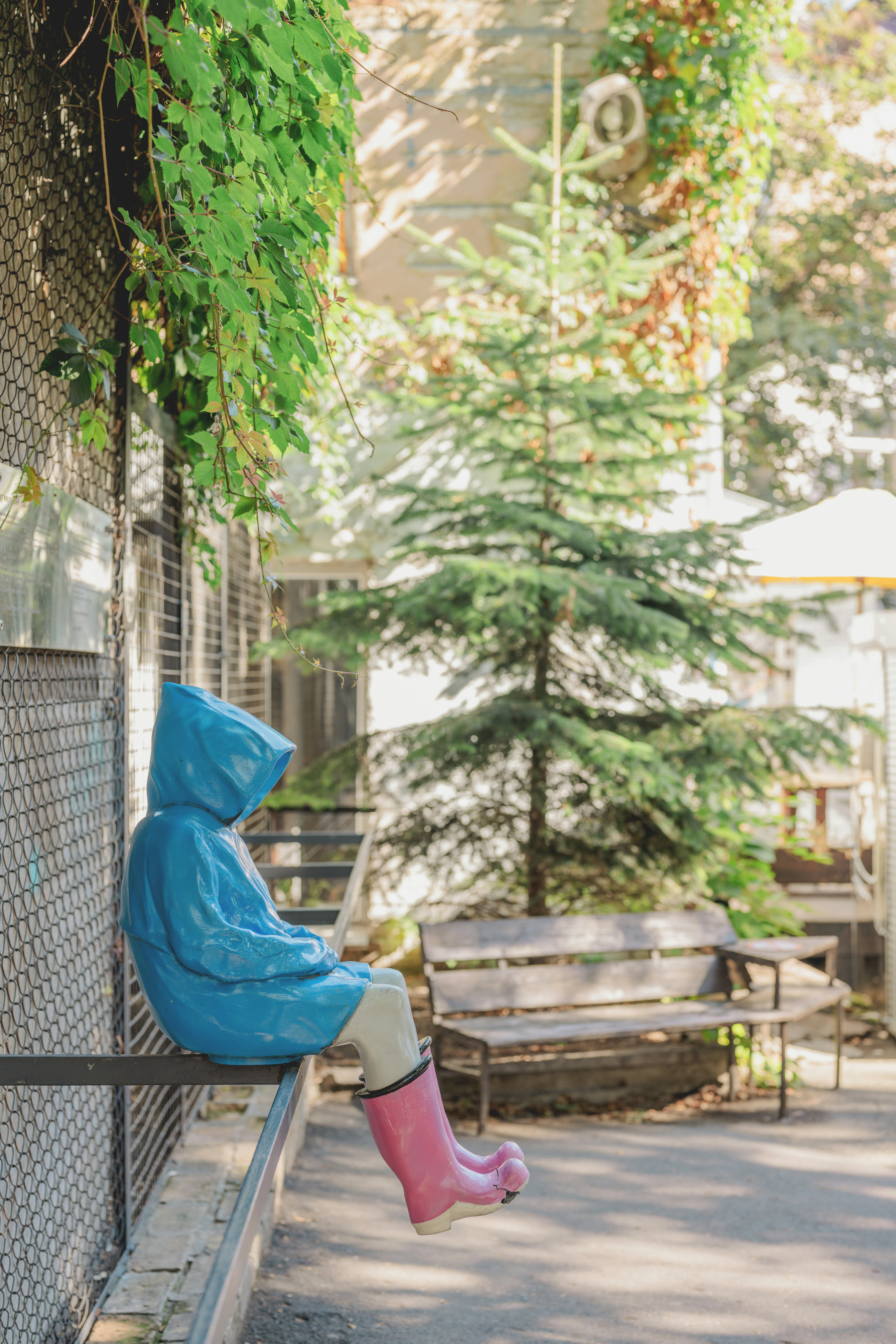 Blue Rain-Themed Hoodie and Pink Boots in a Quiet Courtyard