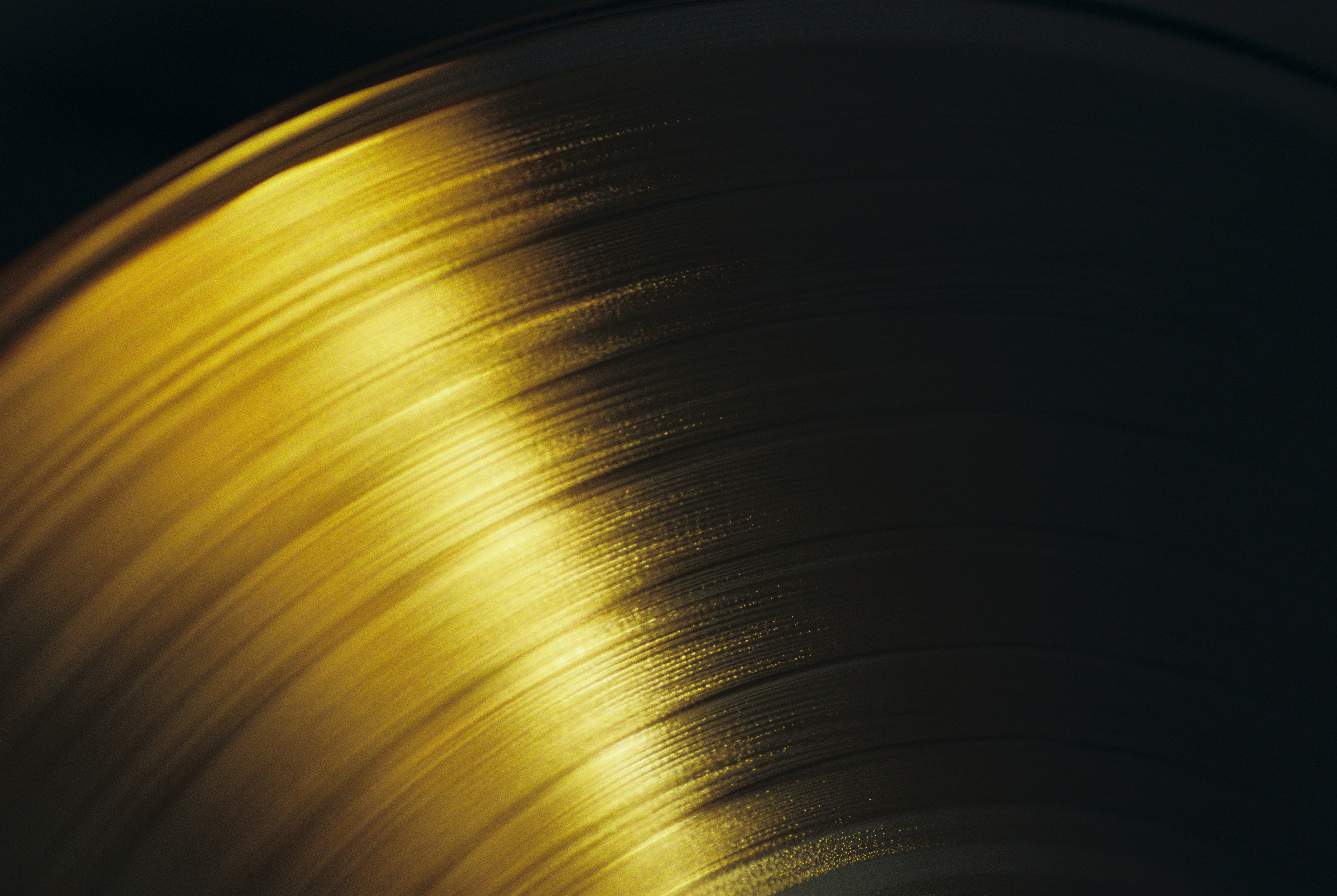 Golden Crescent: A Close-Up of Brushed Light on a Spinning Surface