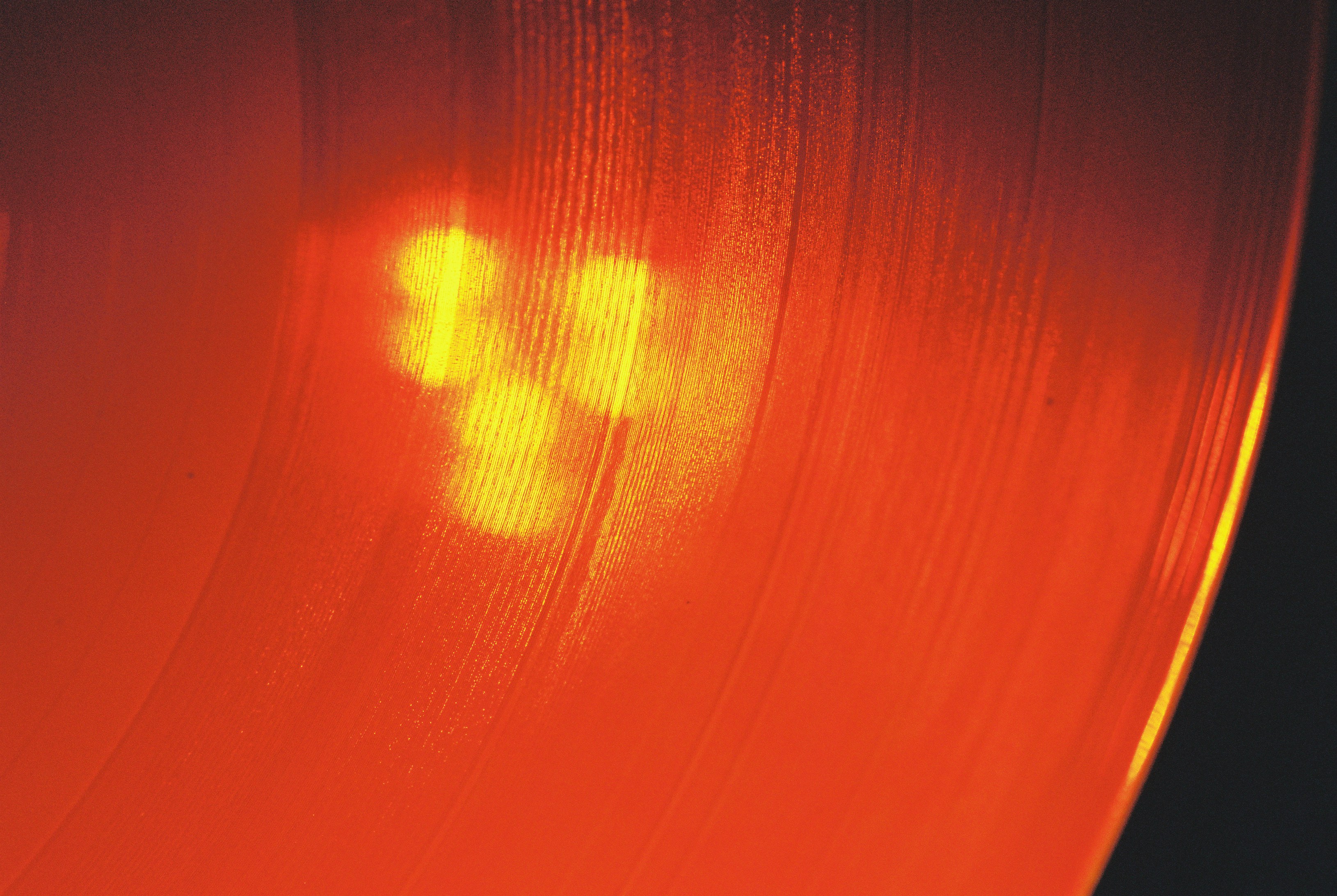 Molten Dawn: A Glowing Lens Slice Revealing Orange Pulse