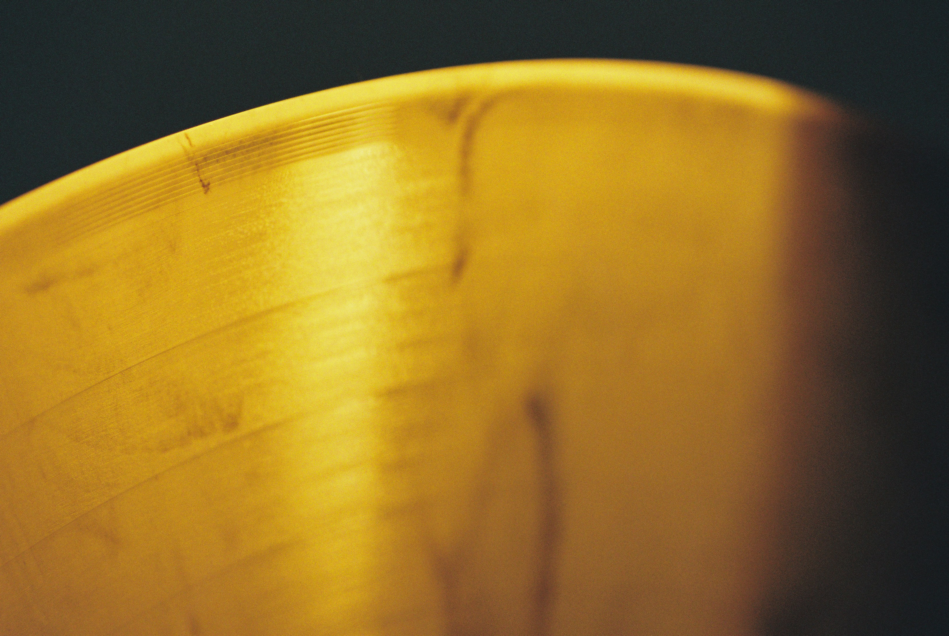 Amber Curve: Close-Up of a Gleaming Yellow Surface
