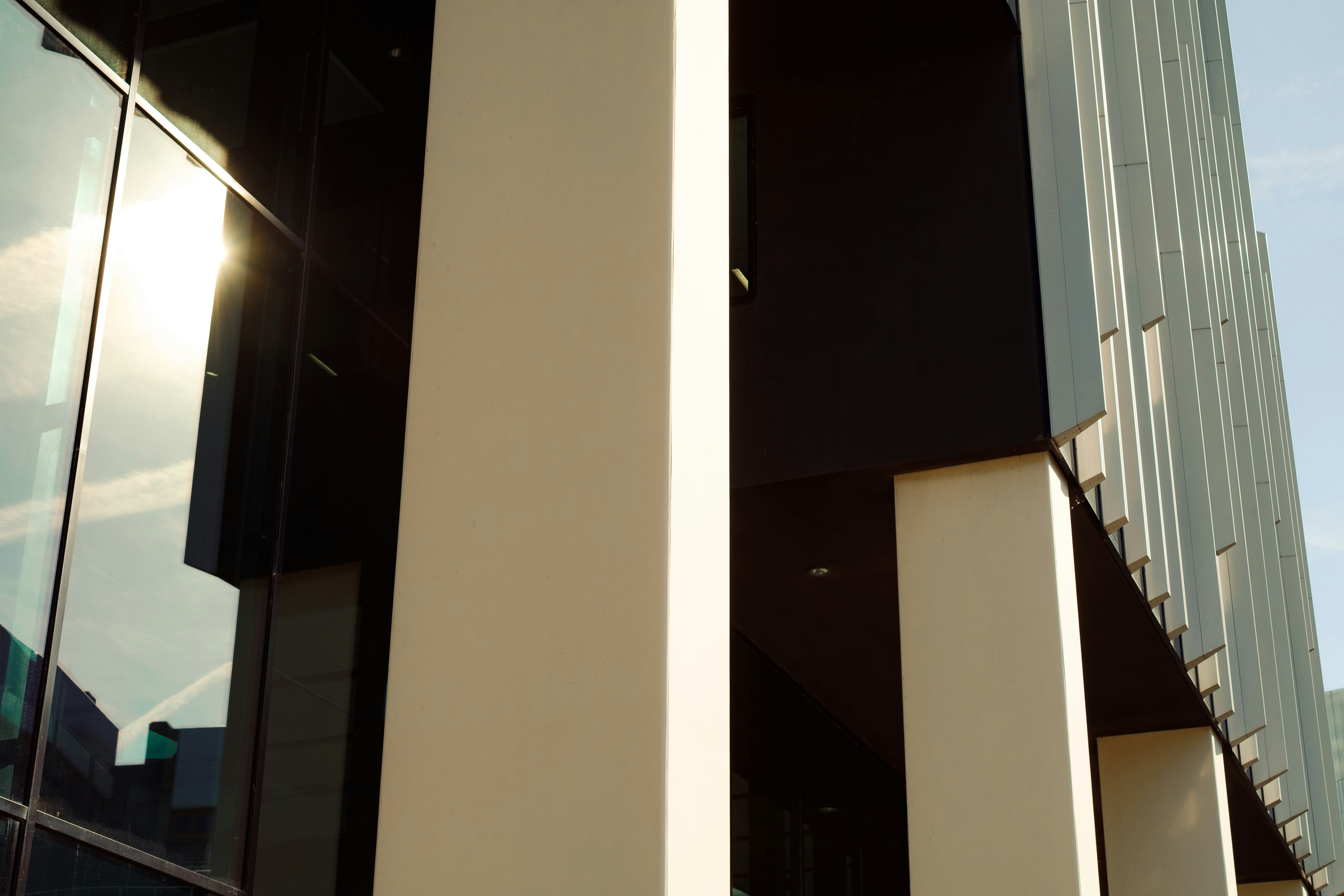 Concrete Geometry: Sunlit Pillars and Glass Facades