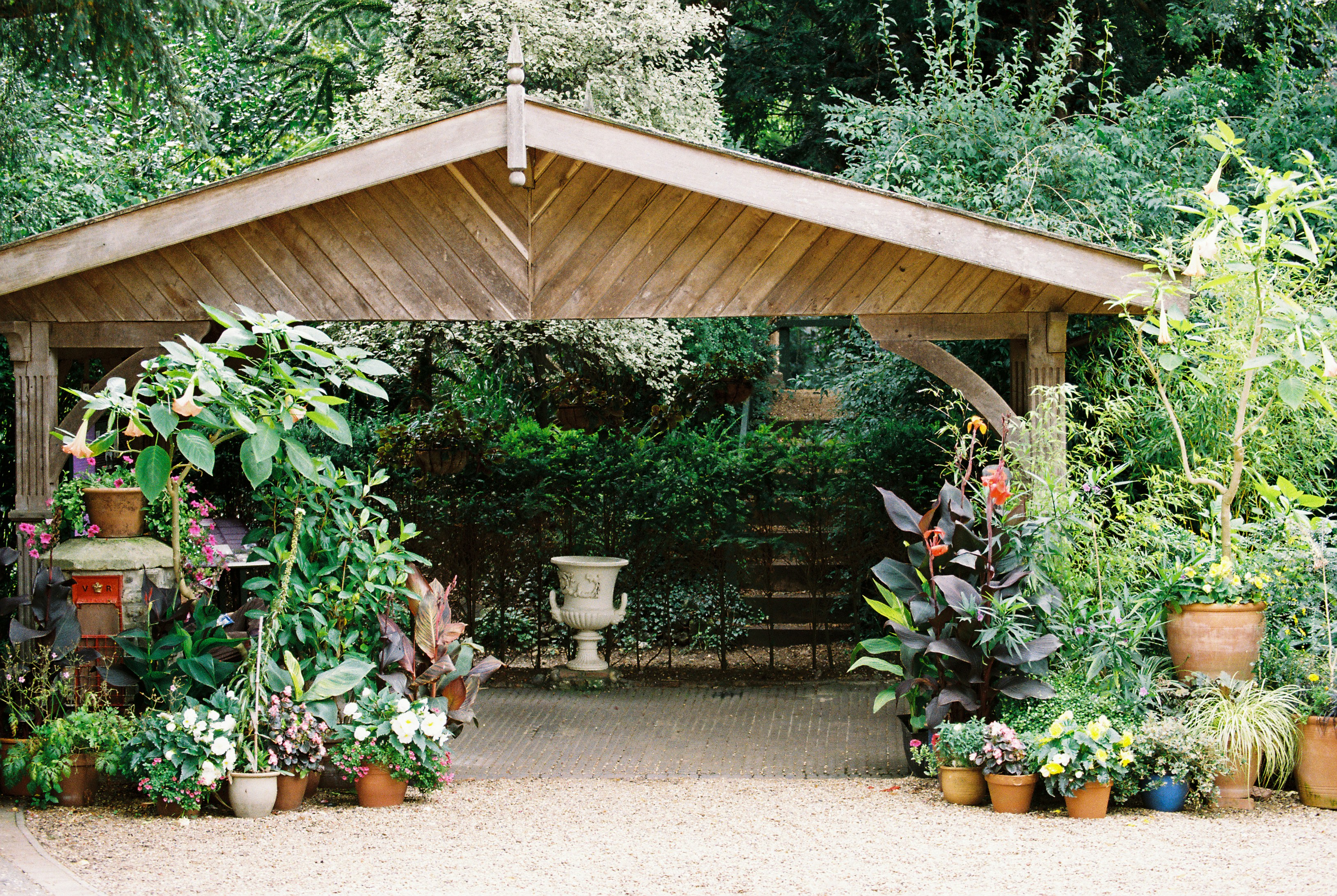 Floral Courtyard Portal: Garden Archway Framed by Verdant Pots