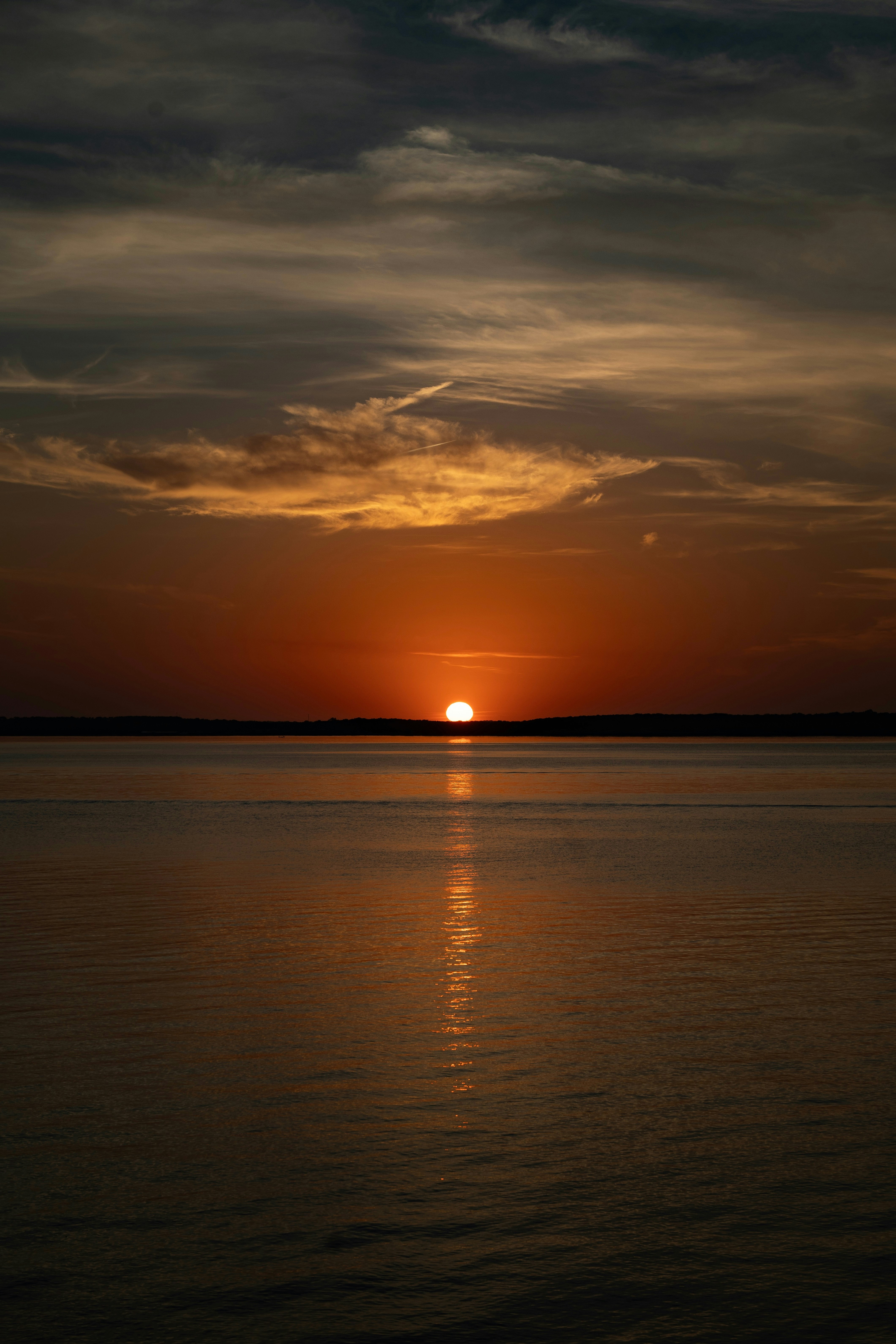 Sunlit Horizon: A Quiet Sunset Over Calm Waters