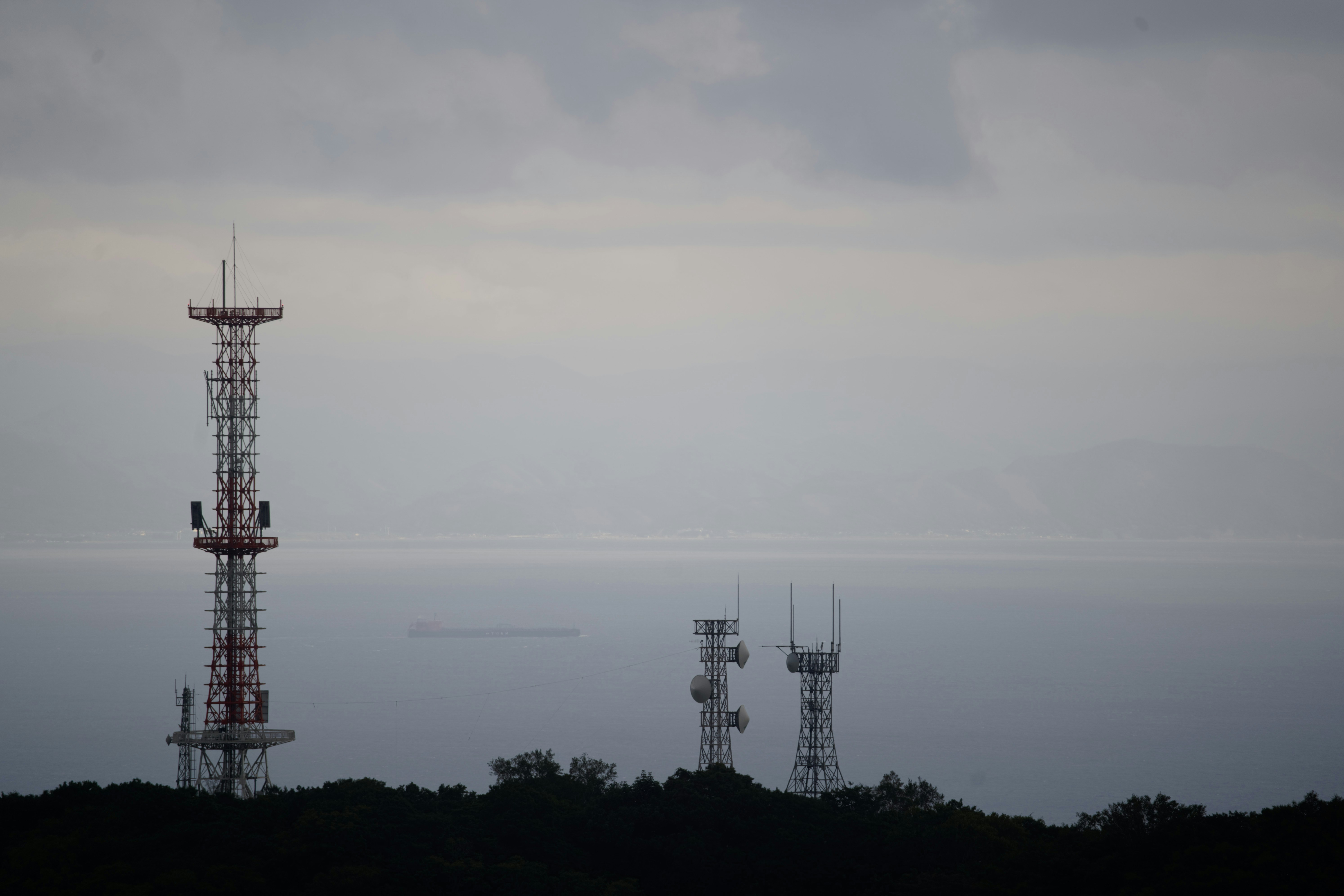 Silhouetted Skyline: Cellular Towers Framed by Distant Horizon