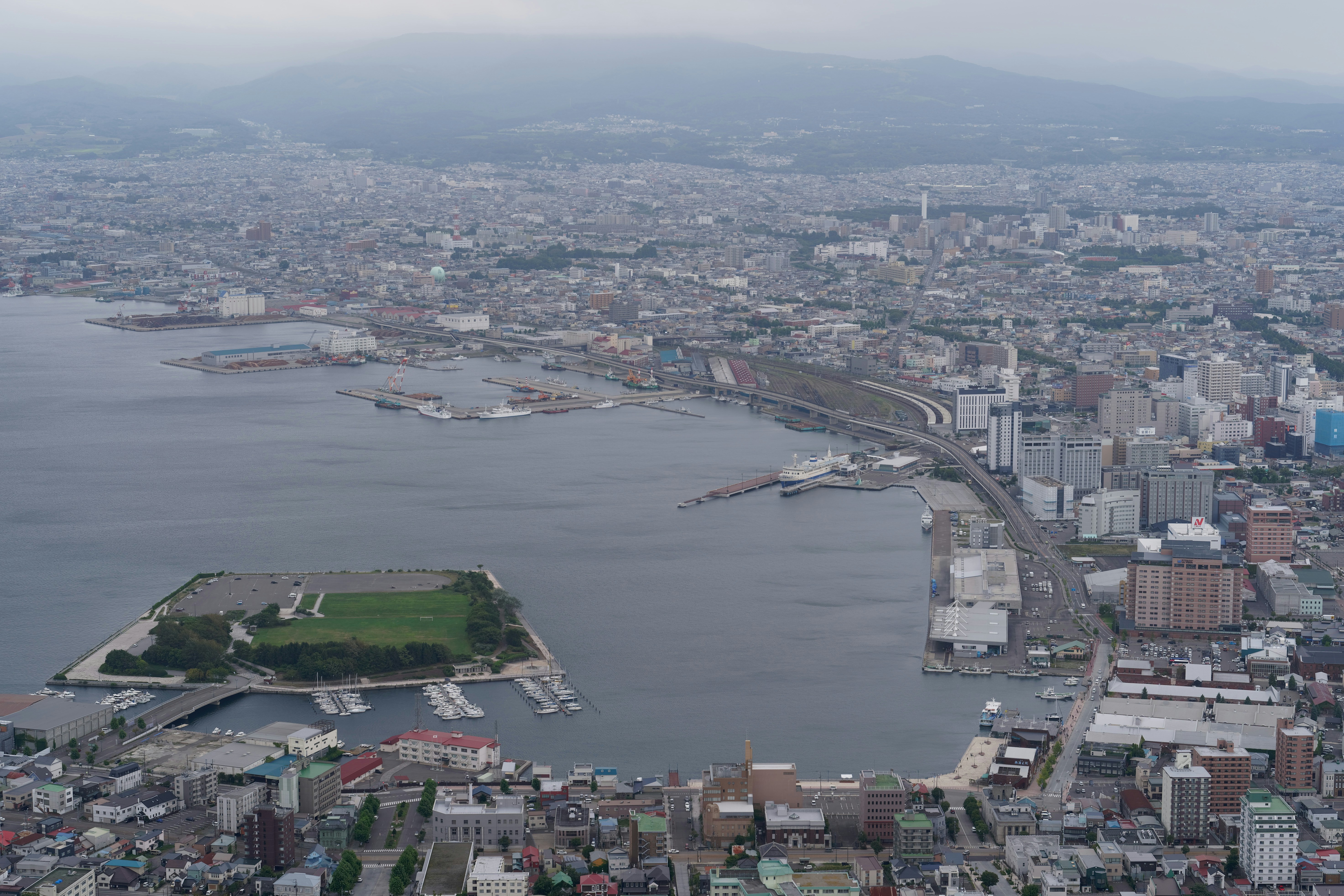 Harbor Prism: Aerial Gridlines Over a Coastal City