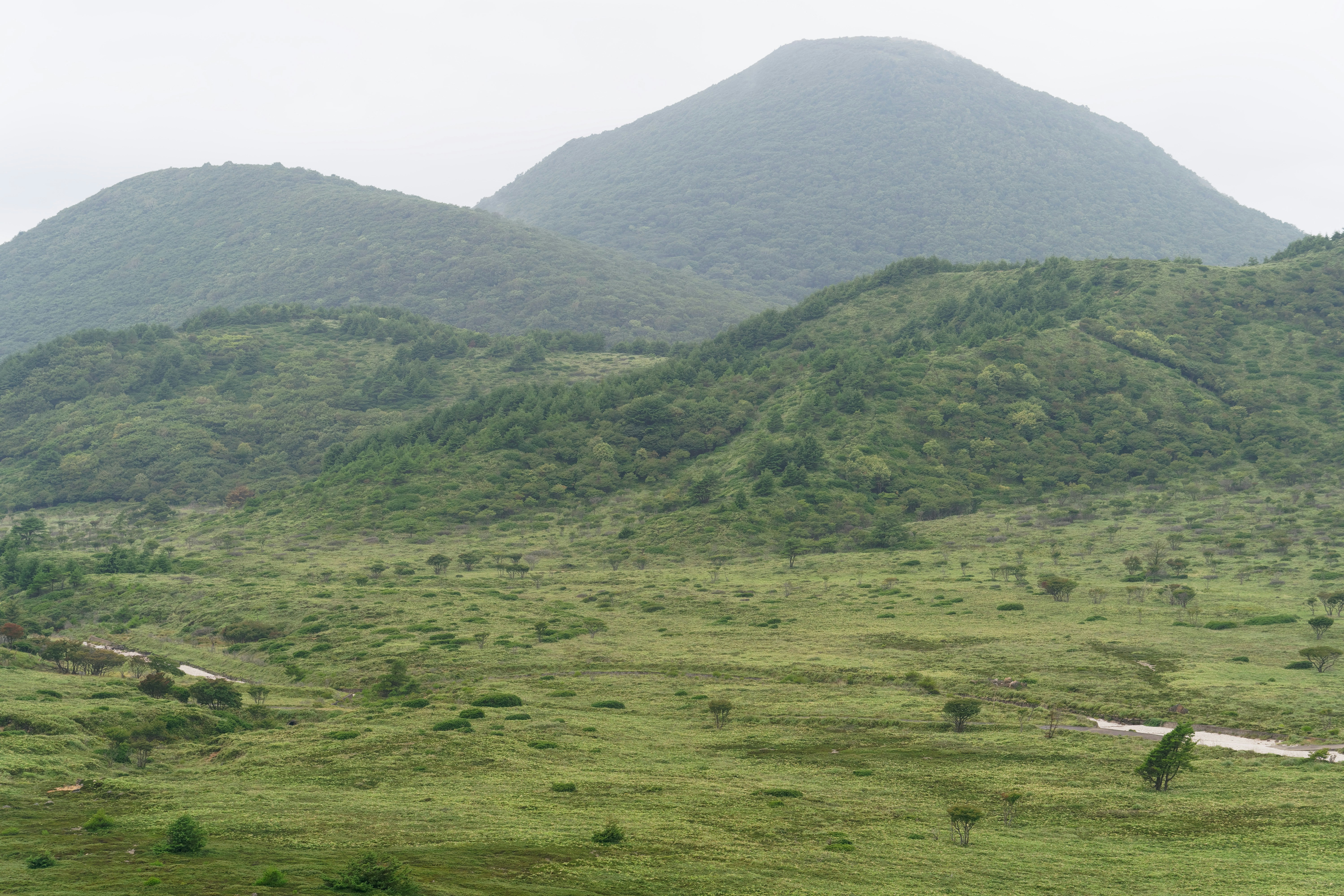 Green Basins Beneath a Quiet Peak