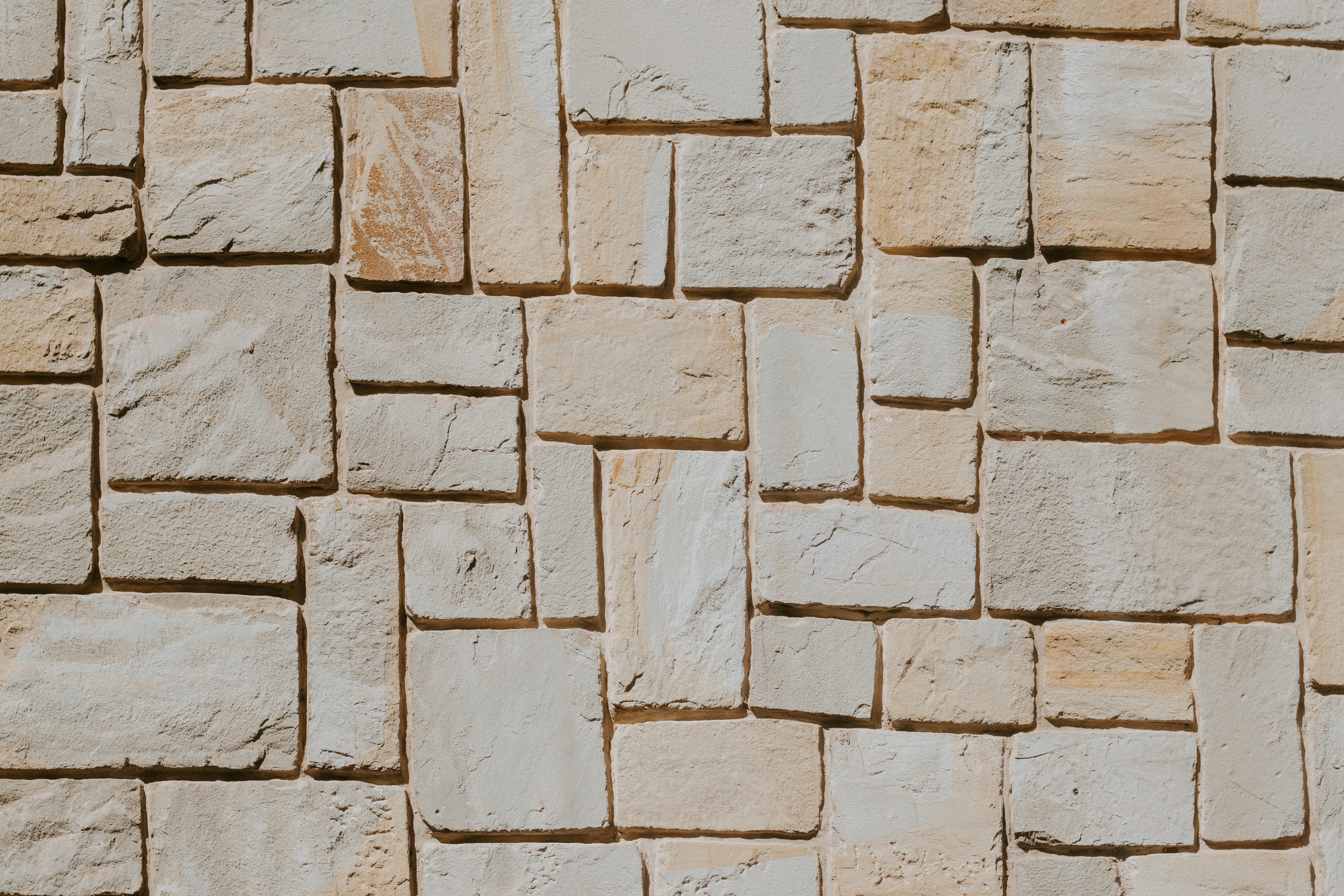 Staggered Stone Mosaic: Sunlit Rectangles in Quiet Wall