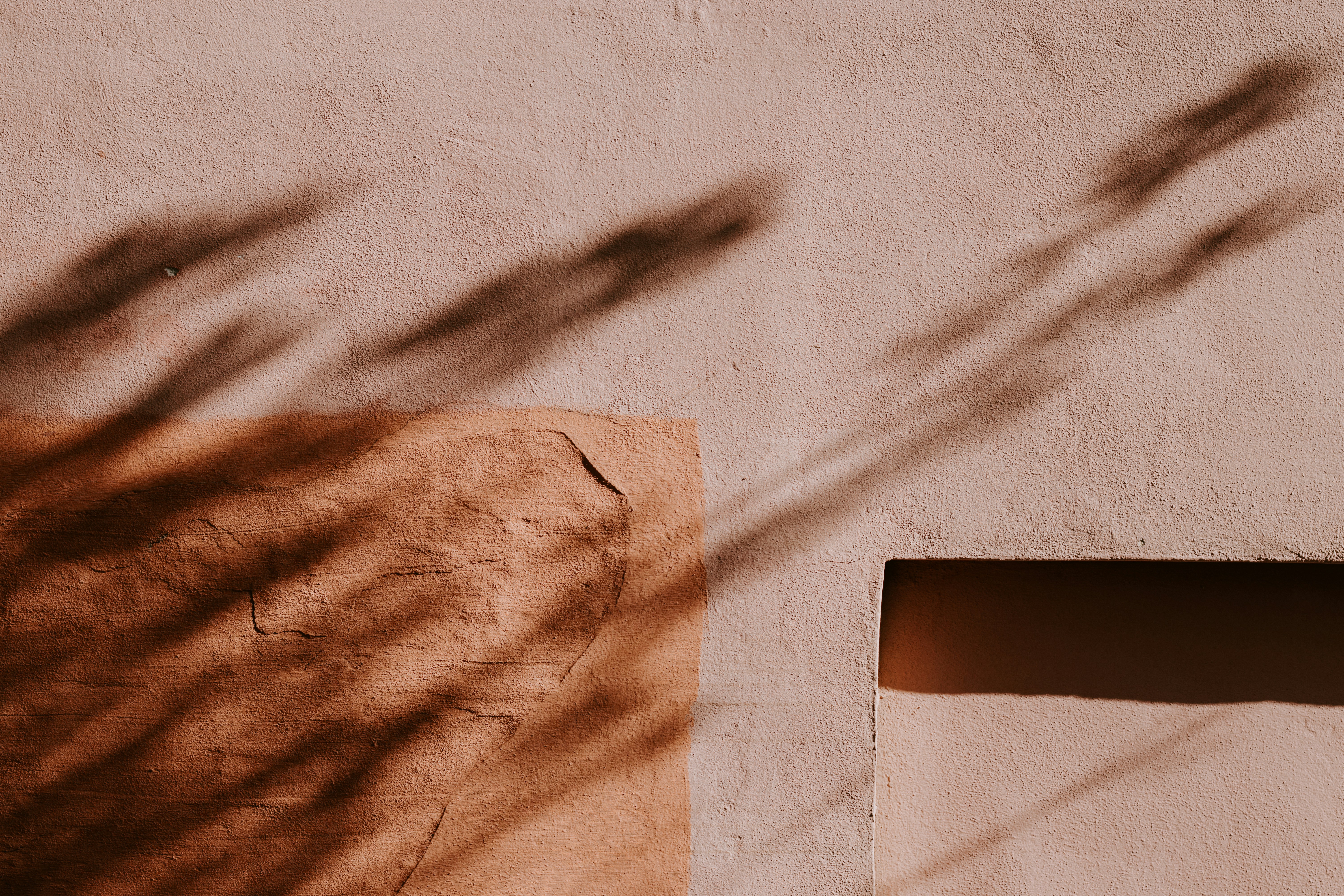 Shadowed Corner: Subtle Geometry on a Sunlit Wall