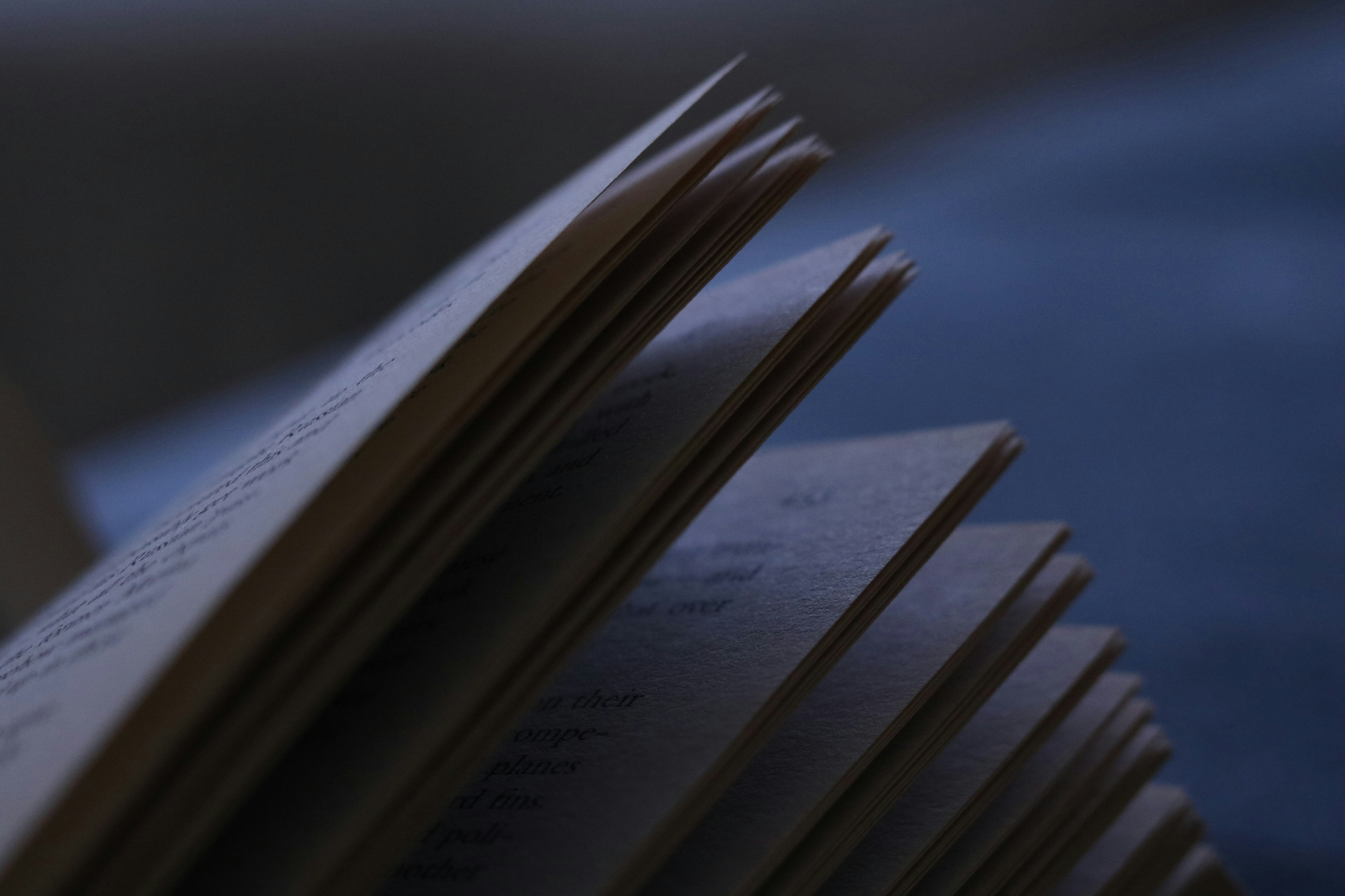 Close-up of a Delicately Fanned Book Pages in Dim Light