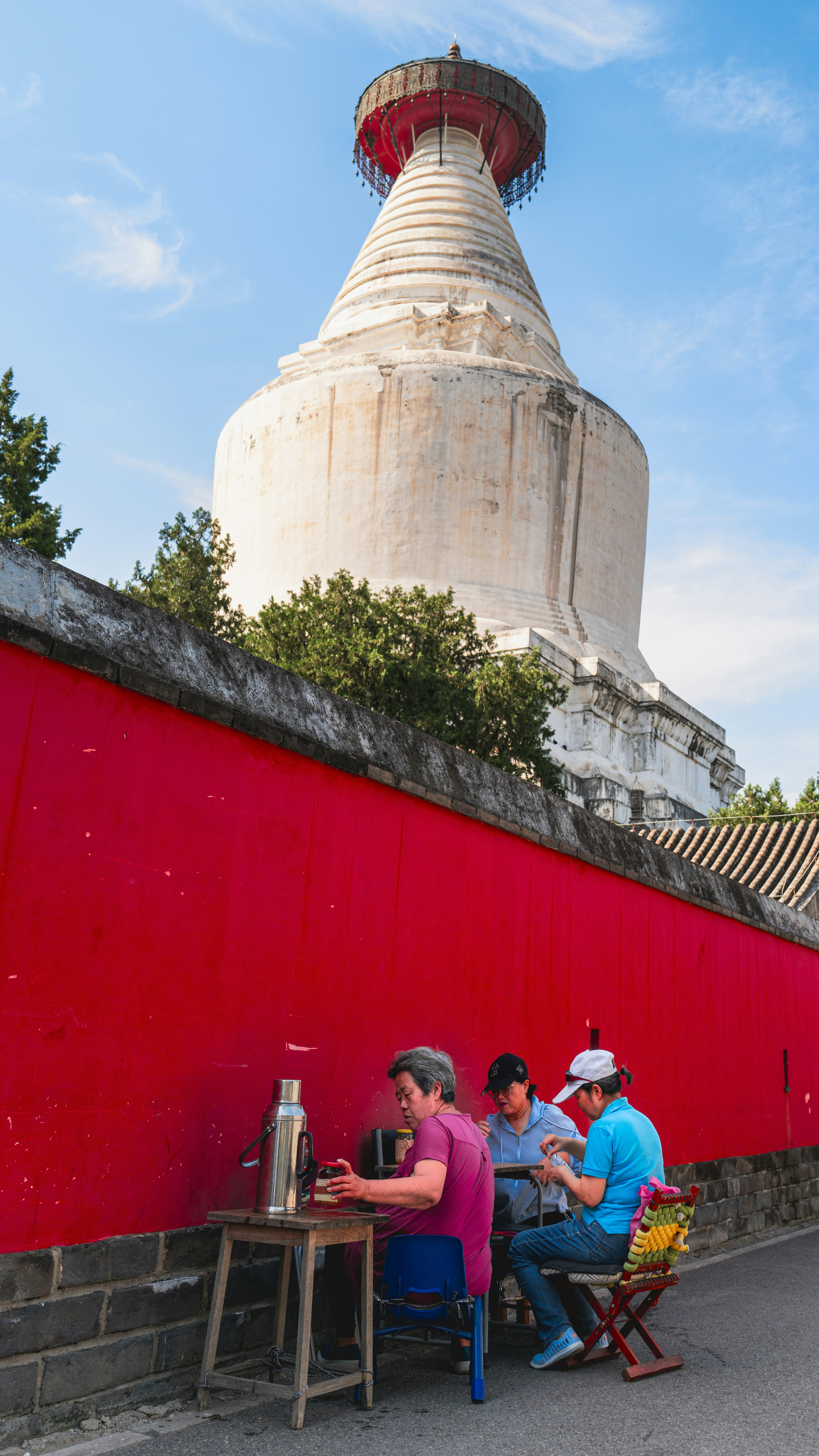 Vendors at the Red Wall: Tea, Trade, and a Towering Landmark