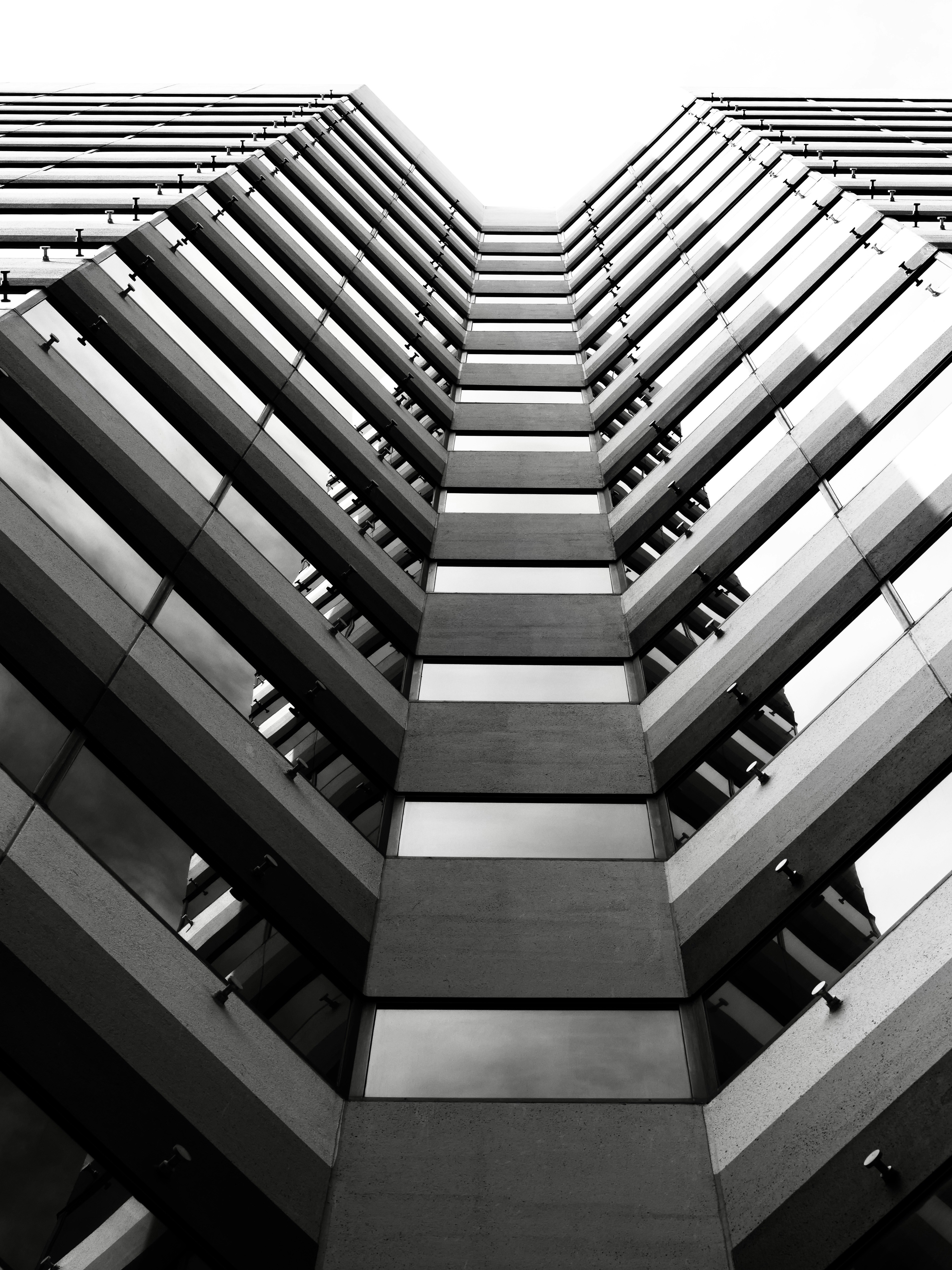 Symmetry Ascends: A Monochrome Facade Pierces the Sky