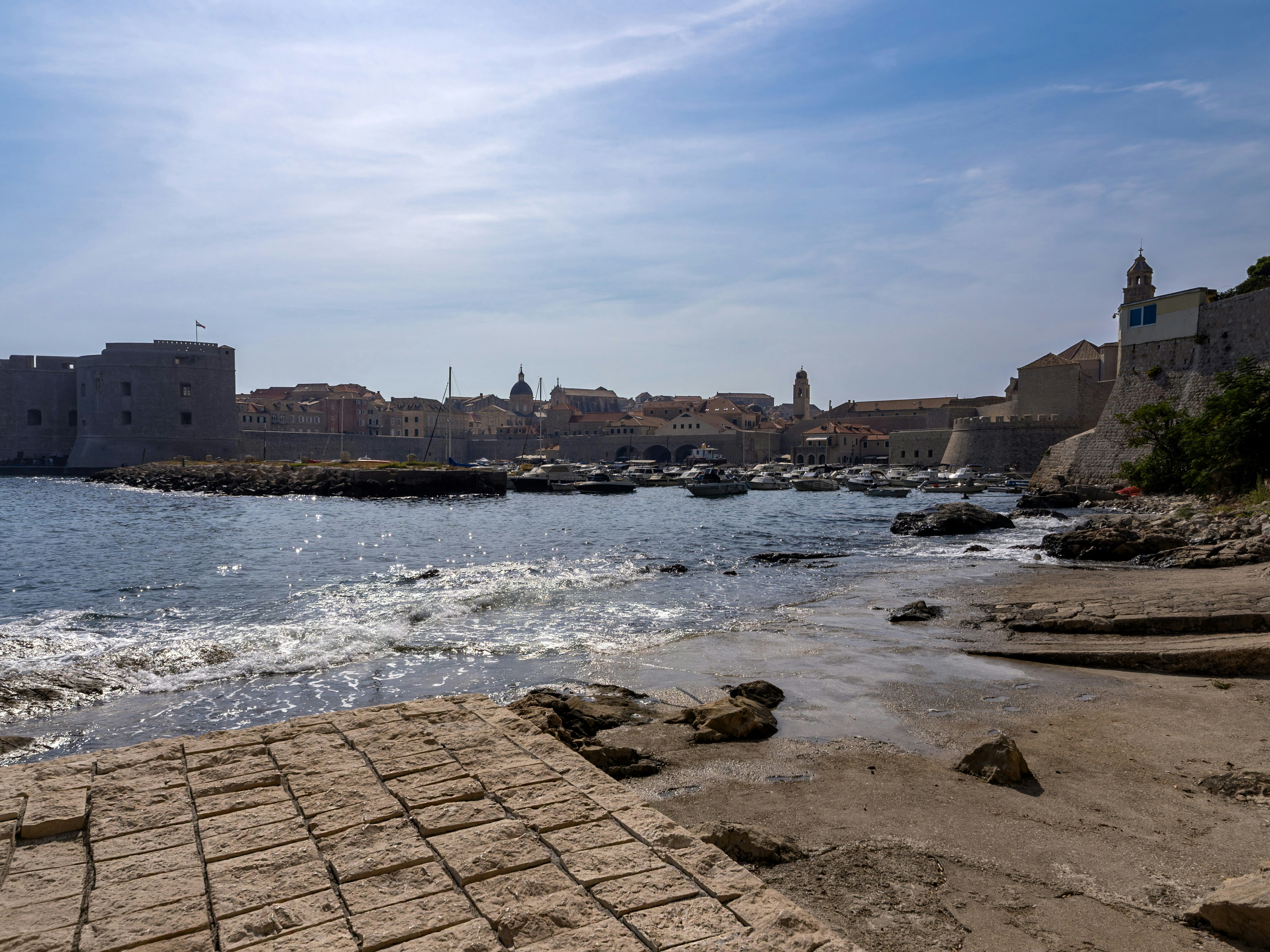 Backlit view of Dubrovnik Old Town across the harbour