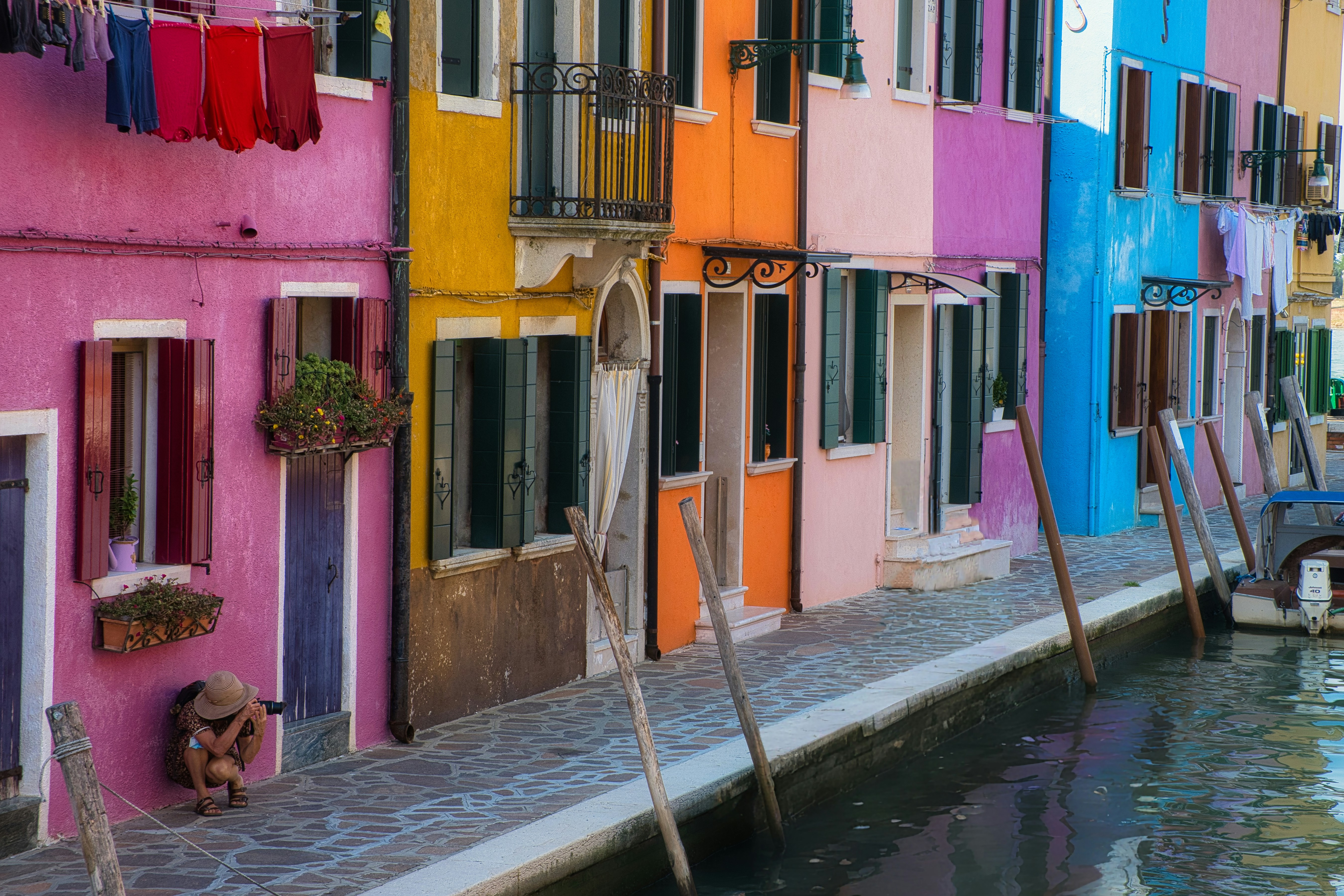 Vibrant Canalfront: A Row of Colorful Facades Along Water