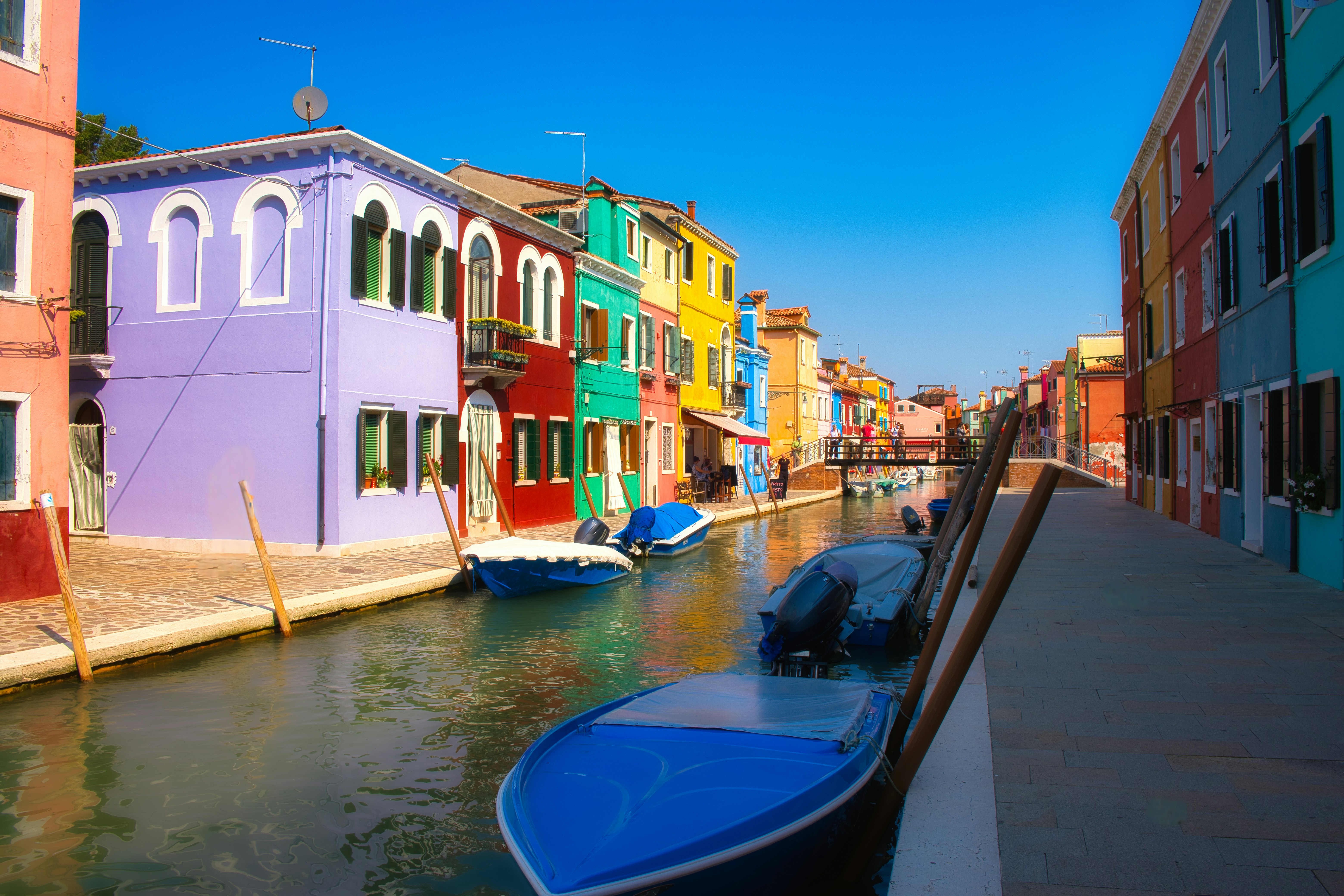 Vibrant Canal Row: A Palette of Island Homes Under Clear Blue Sky