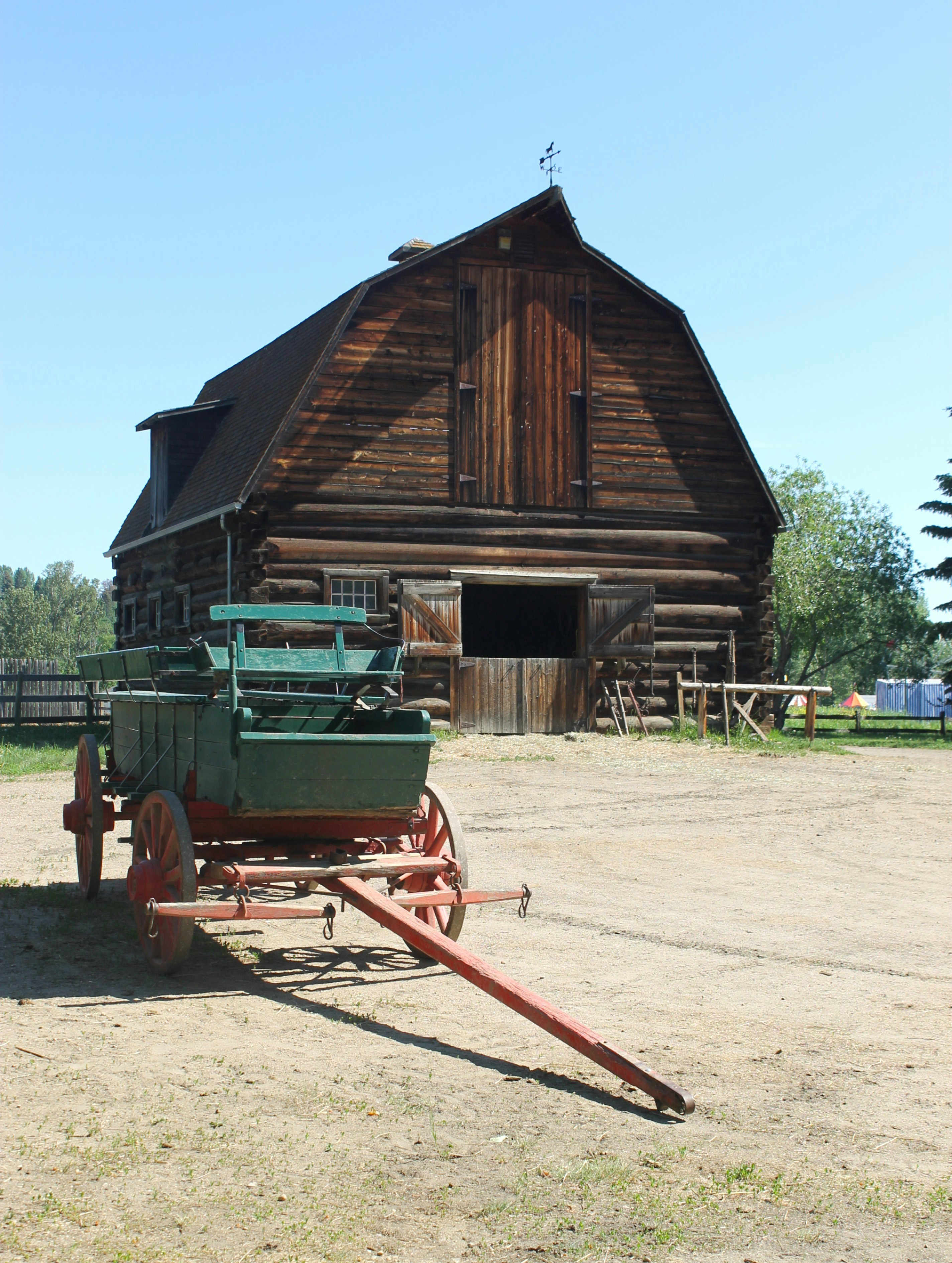Old Barn and Vintage Wagon under a Bright Rural Sky