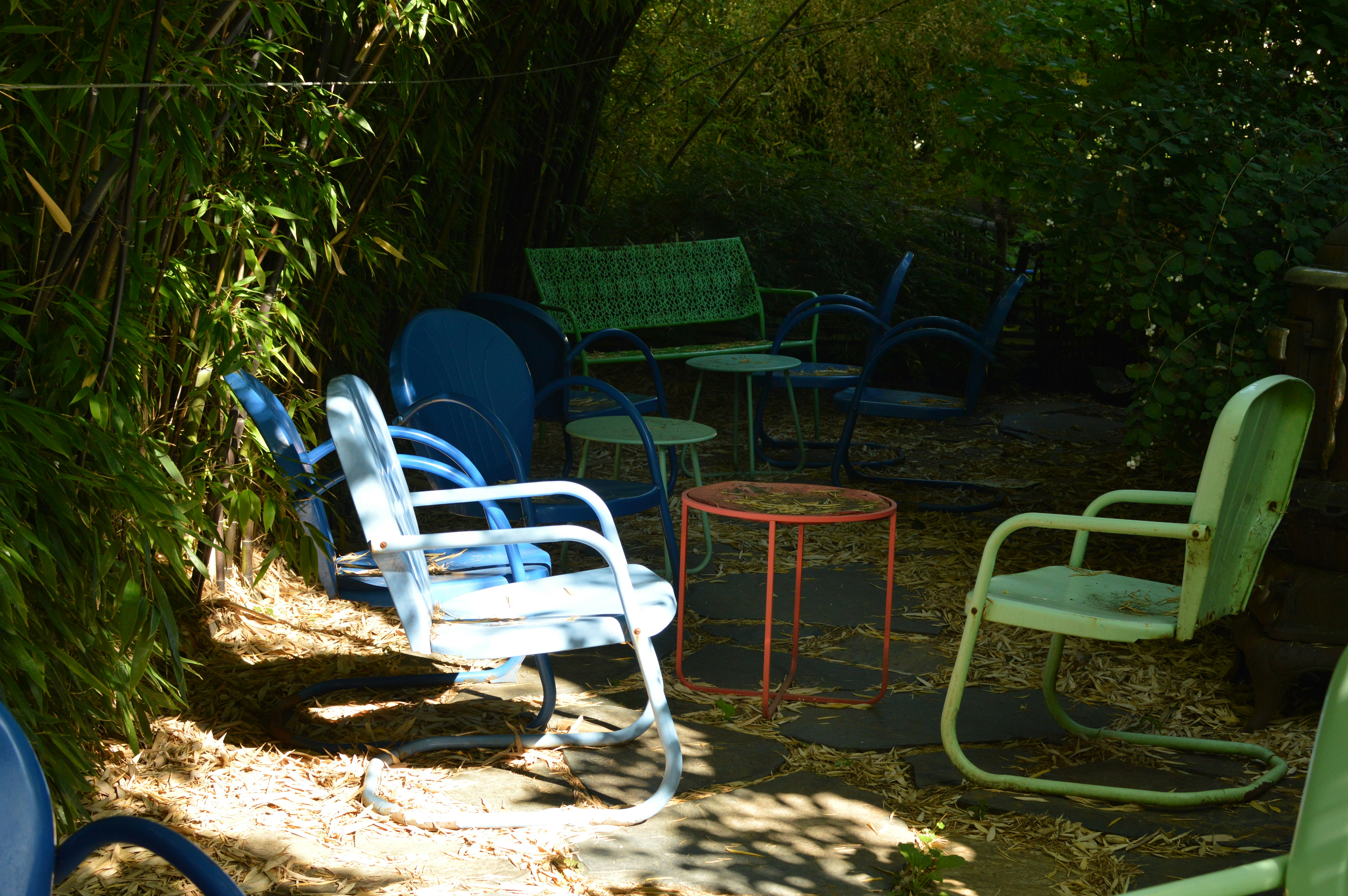 Sunlit Circle of Chairs in a Quiet Garden