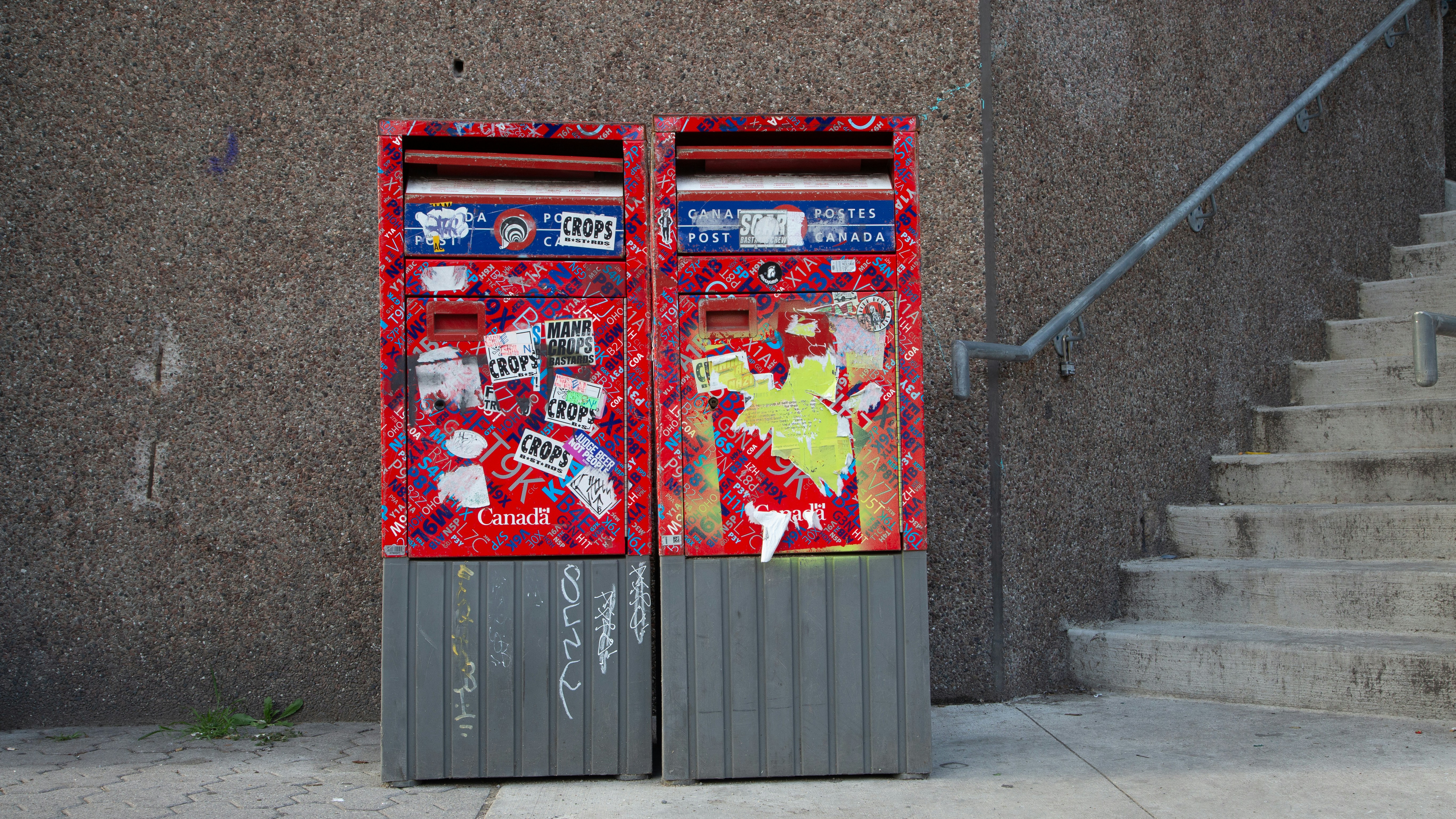 Coloured Mailboxes Framed by Urban Stone and Steps