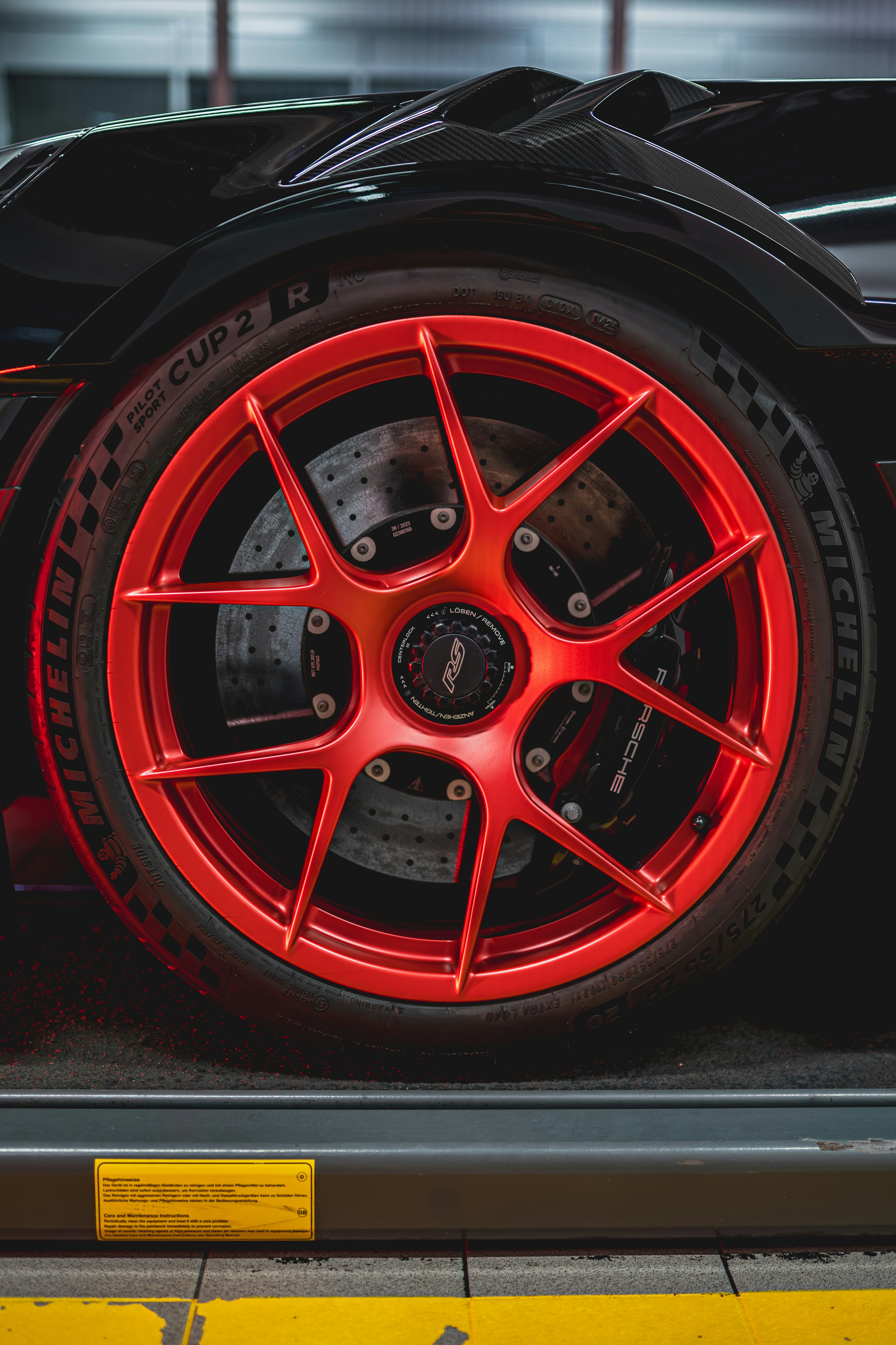 Red Fury: The Porsche Wheel in a Studio Glow
